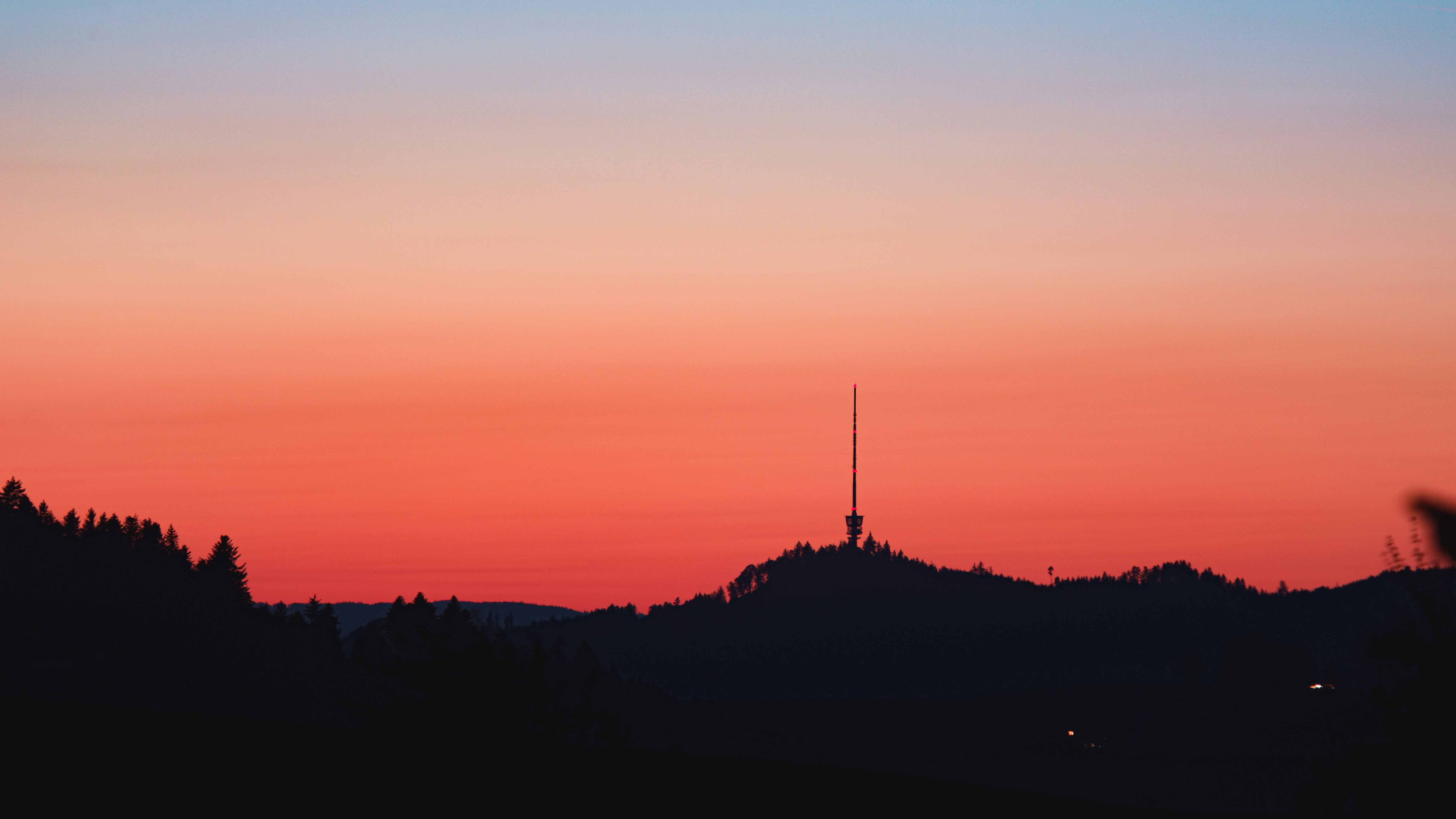 Dusk Silhouette Beneath a Calm Antenna Peak