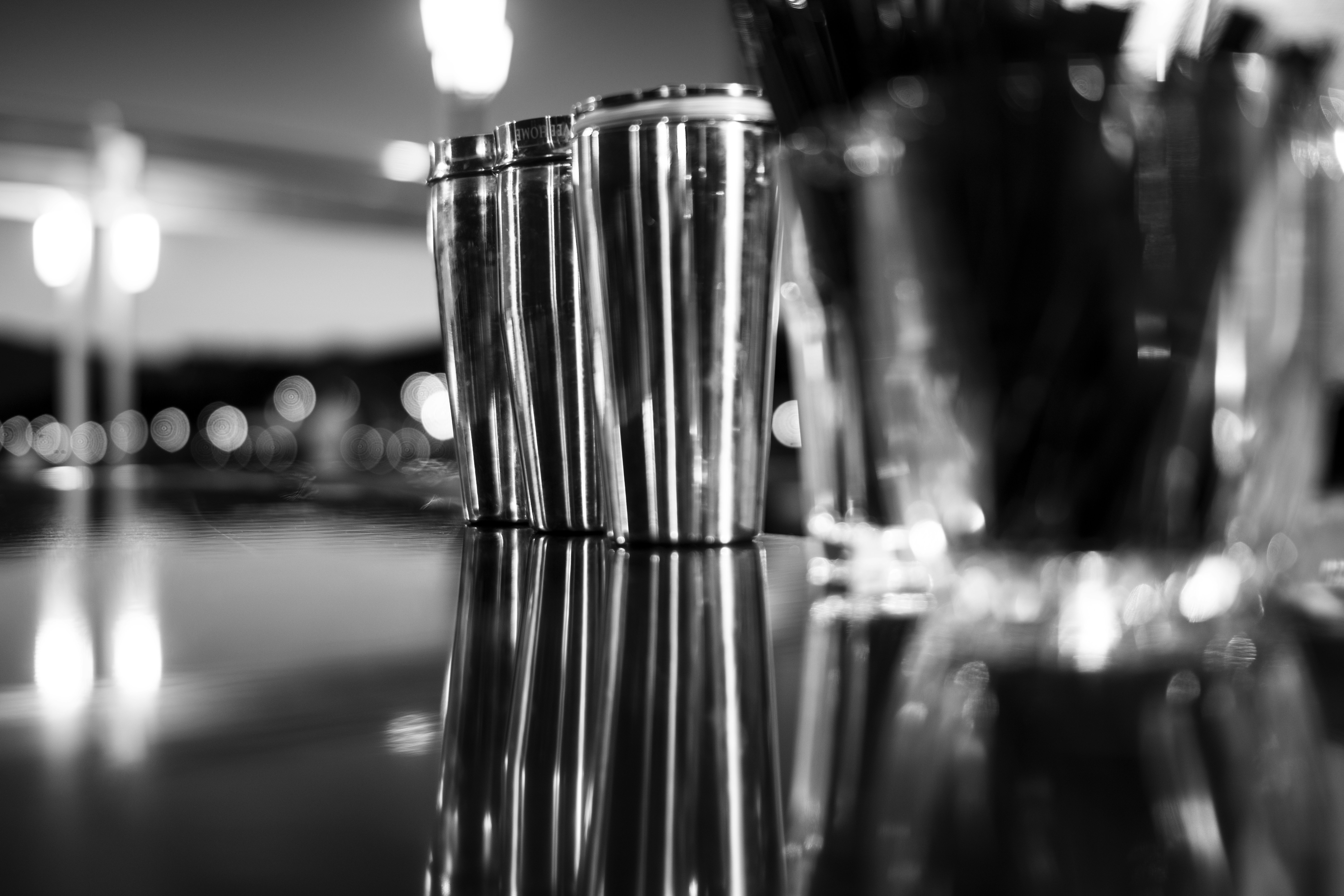 Reflection at the Bar: Stainless Silhouettes in Mono