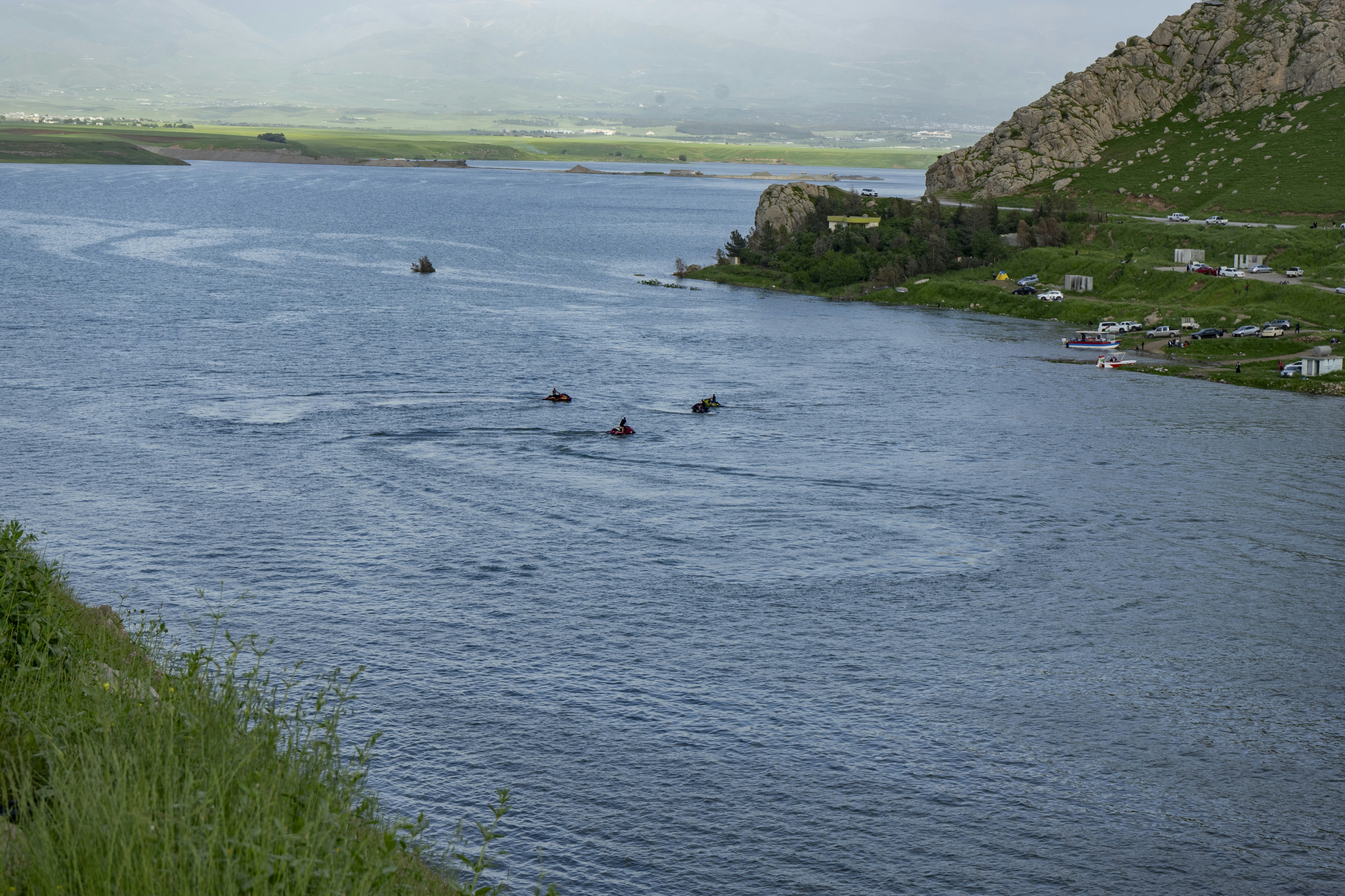 Ridgeside Cove: Boats Tracing Wake Along a Quiet Lake