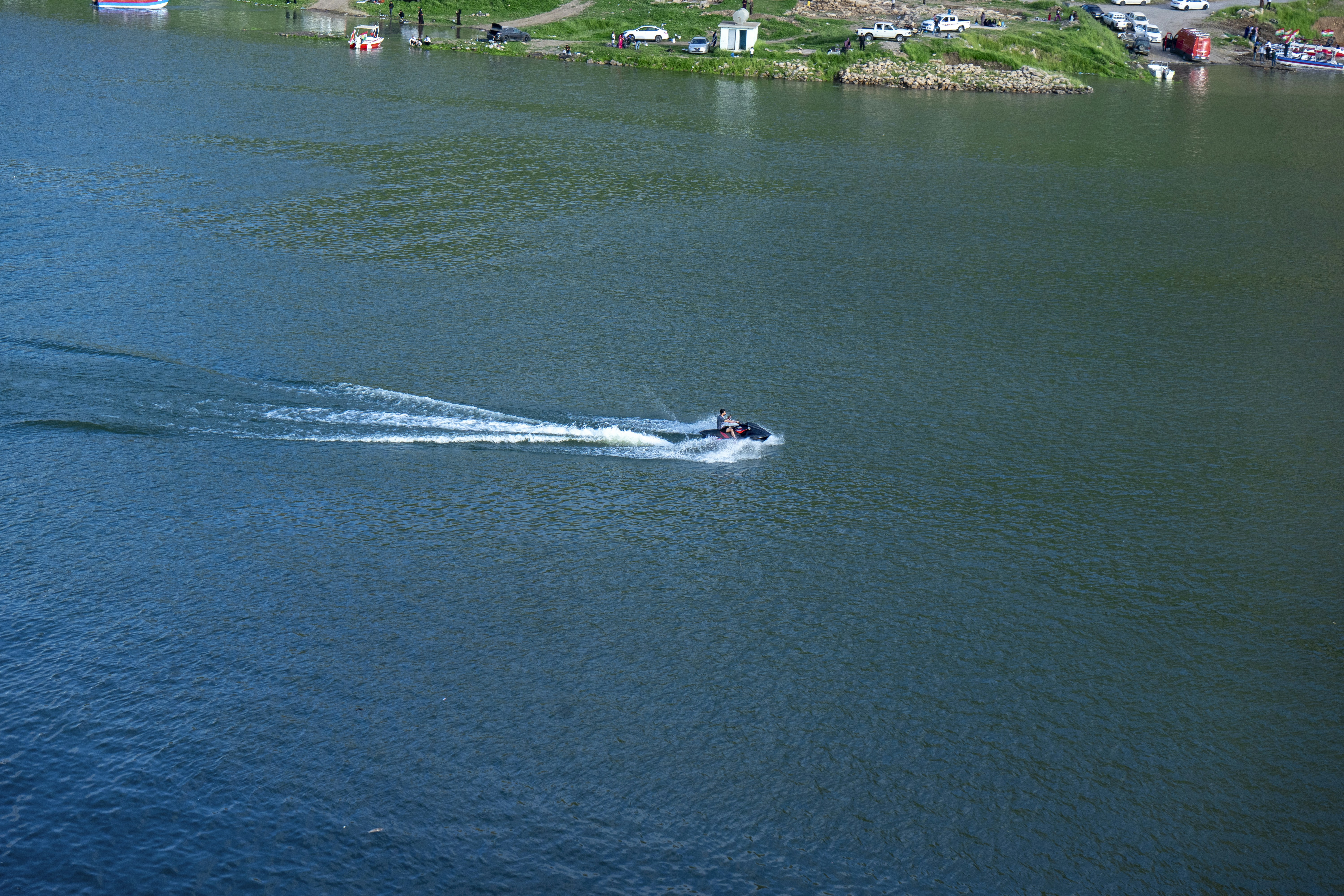 Jet-sled Arc: A lone speedboat slices a sapphire river