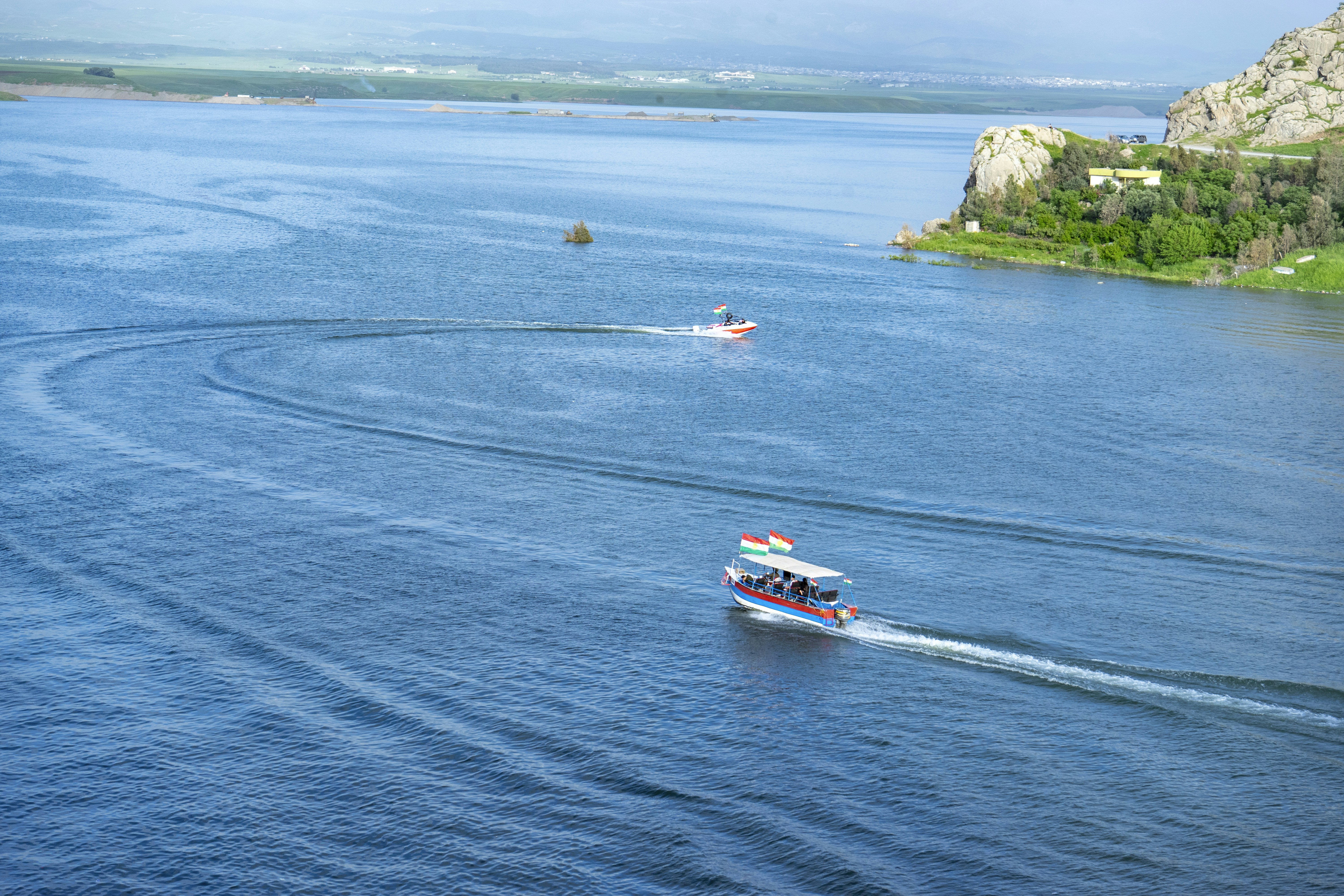 Towboats Cut Through Blue: Aerial View of River Traffic Near Cliffs