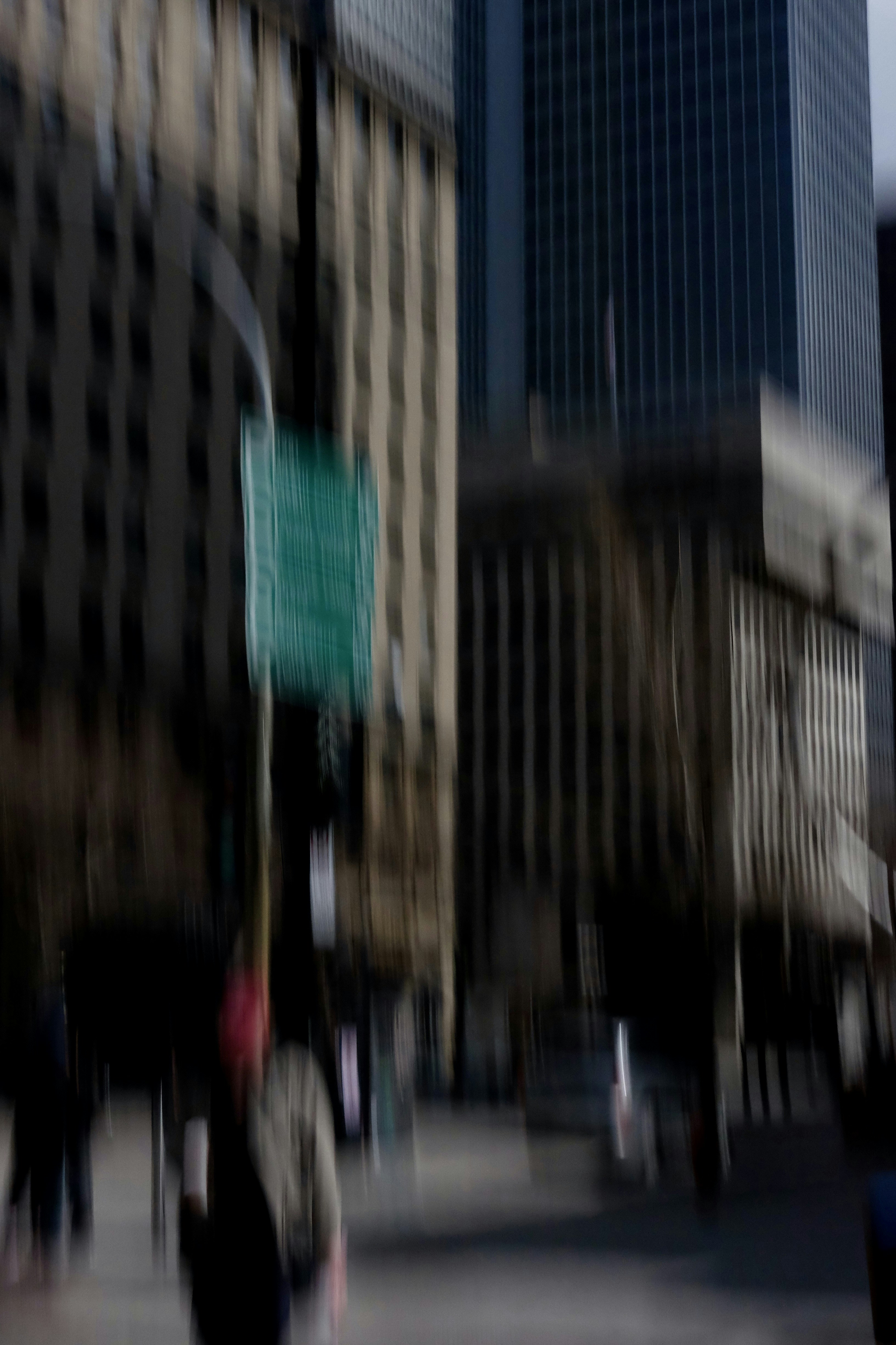 Motion Blur on City Street: Blurred Skyscrapers and Pedestrians