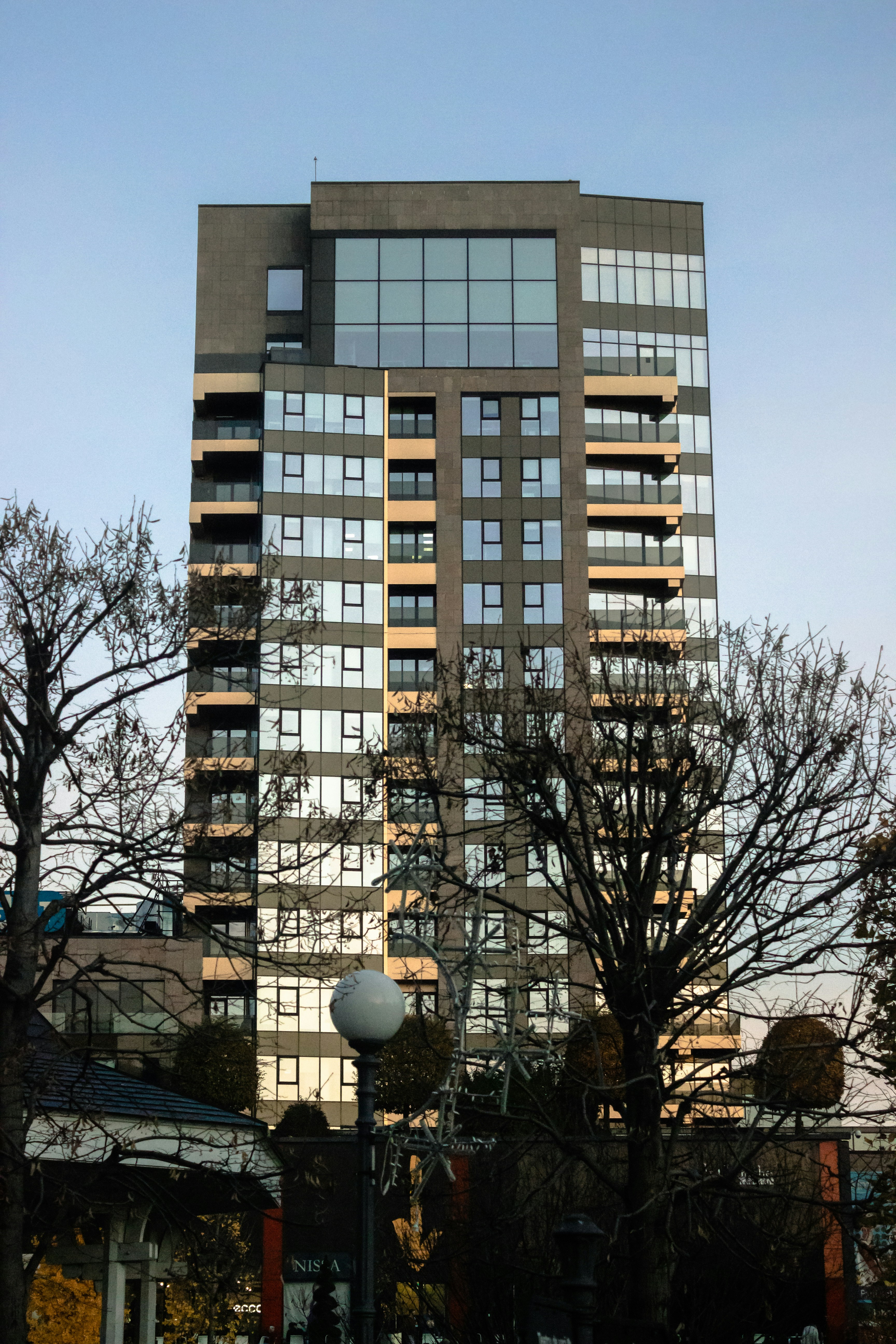 High-rise Concrete Facade: Sunset Light Trims The City Spine