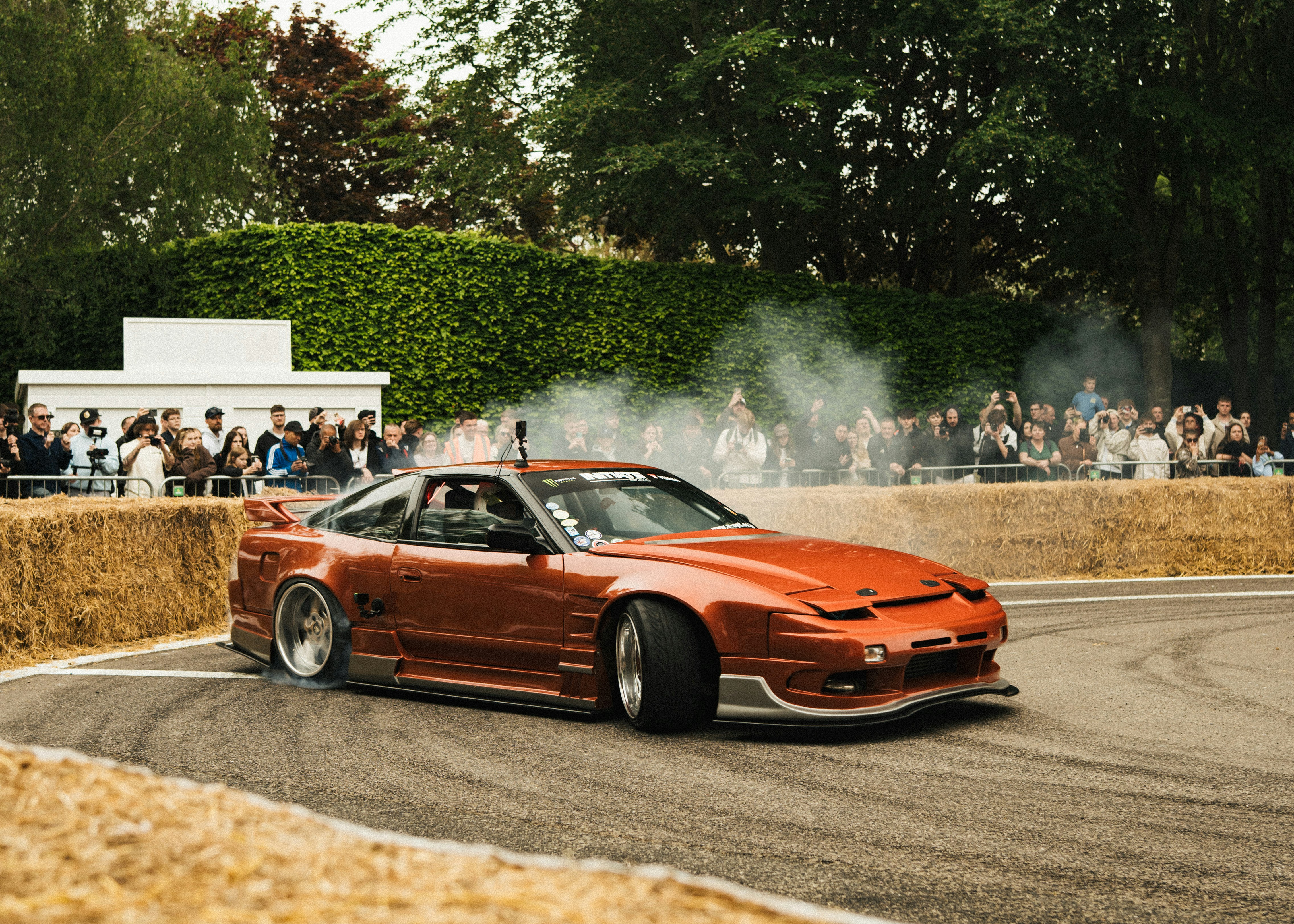 Crimson Drift: A Mitsubishi silhouette in a hay-bale arena