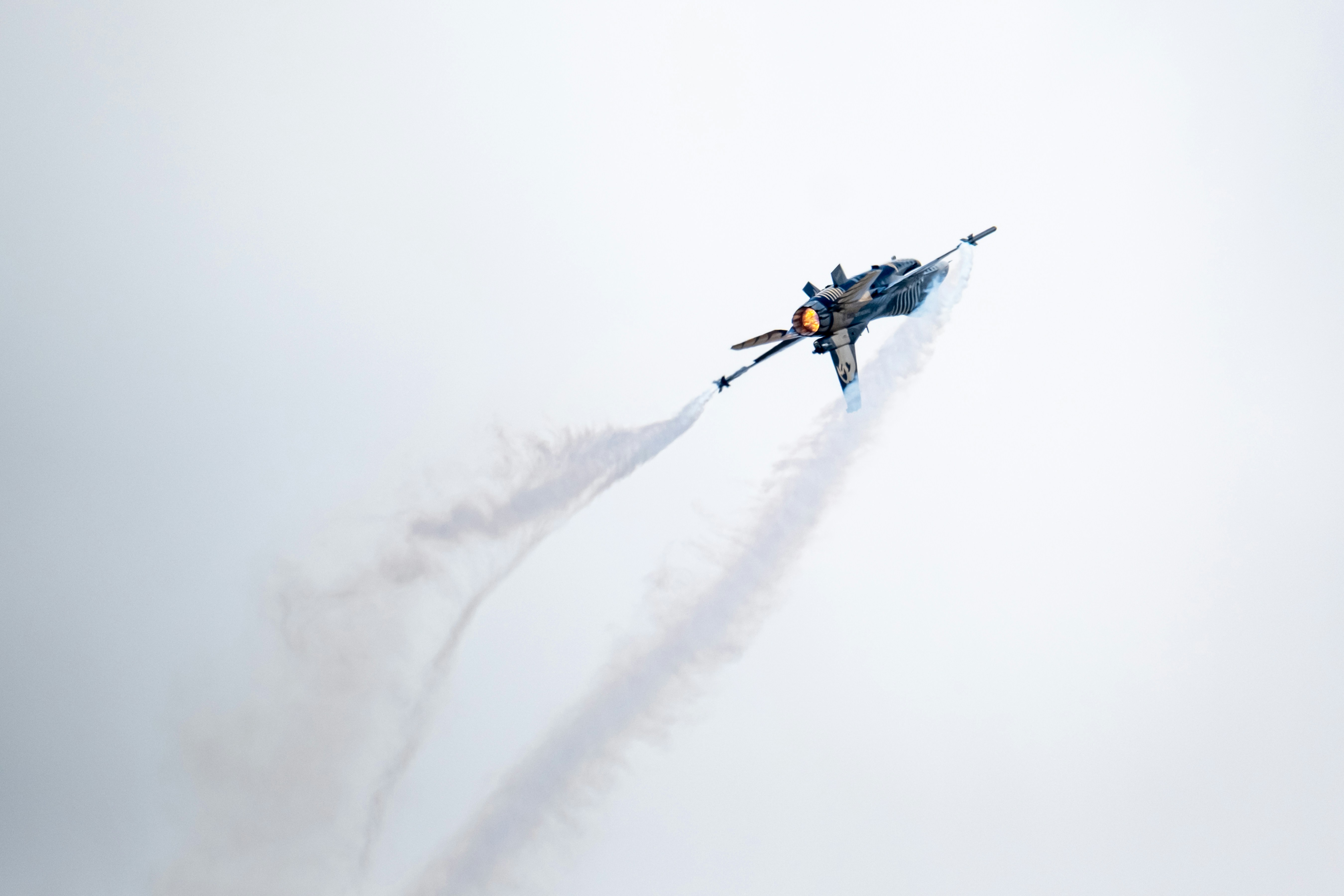 Jet stream ballet: a solo aerobatic launch through pale skies