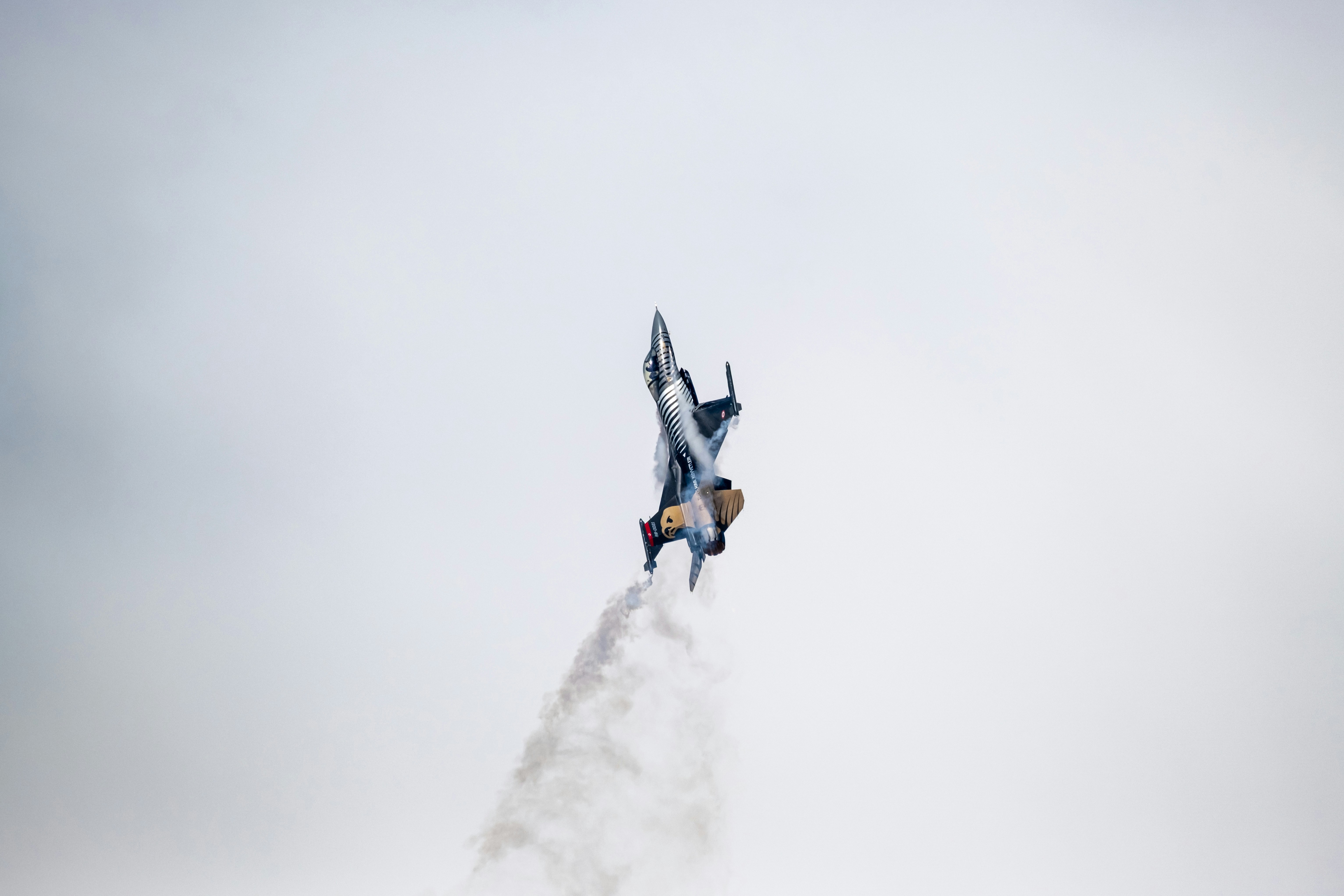 Vertical Burst: A Jet Climbing Through Cloud with Trail