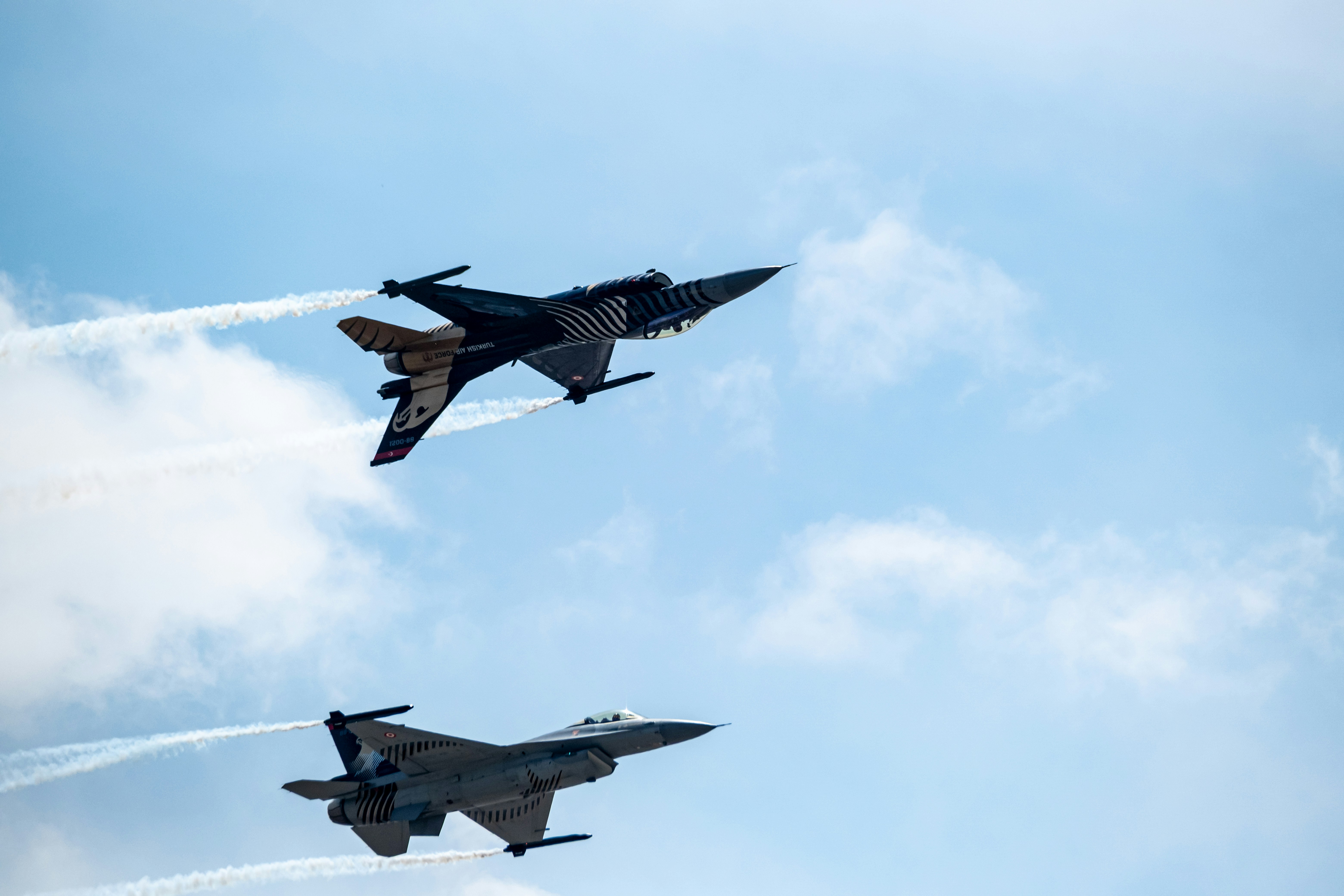 Dual Jet Salute: Daylight Aerobatics Above Breezy Skies