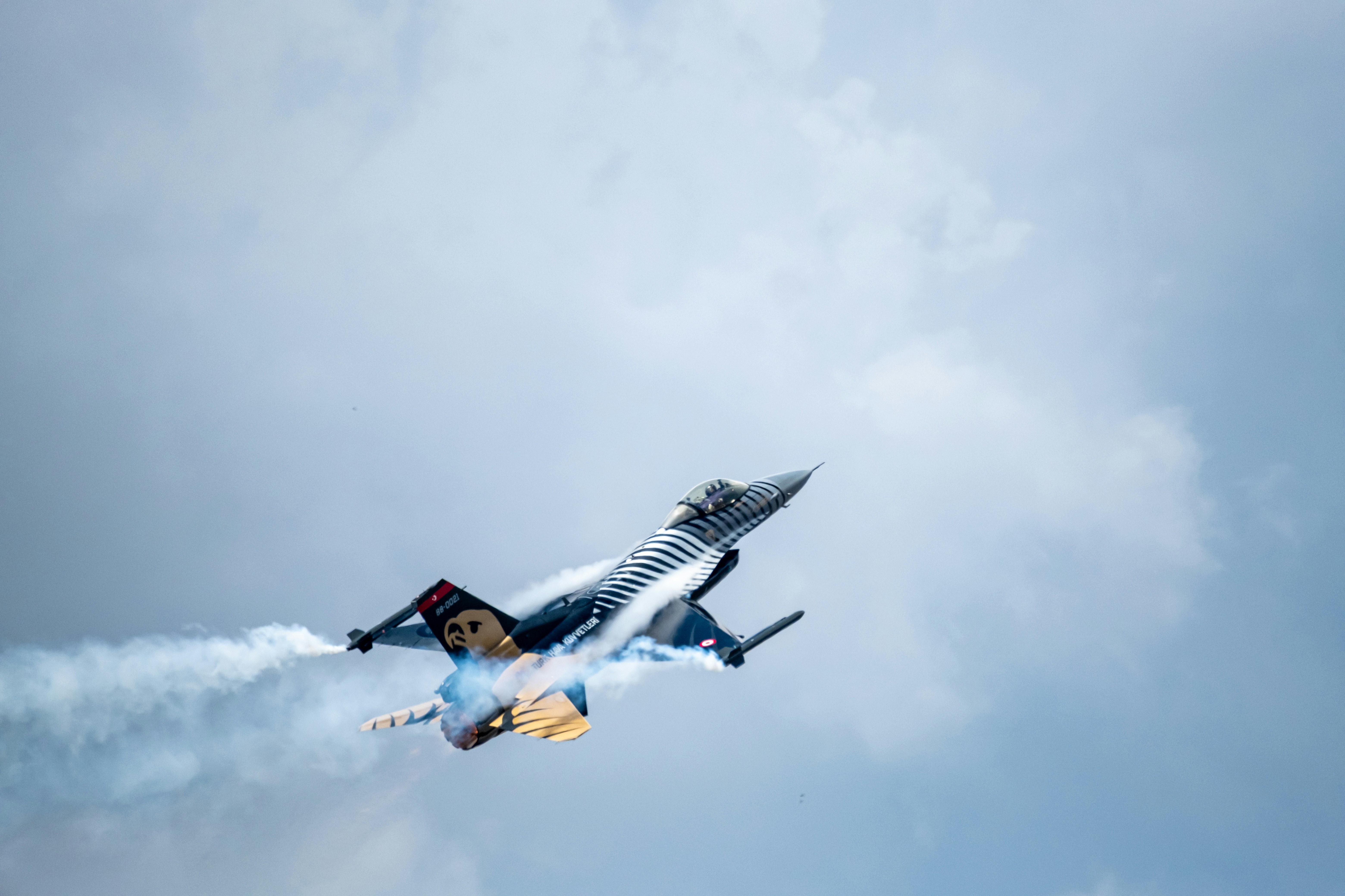 Precision in Blue: A Jet Sparking Smoke Across a Quiet Sky