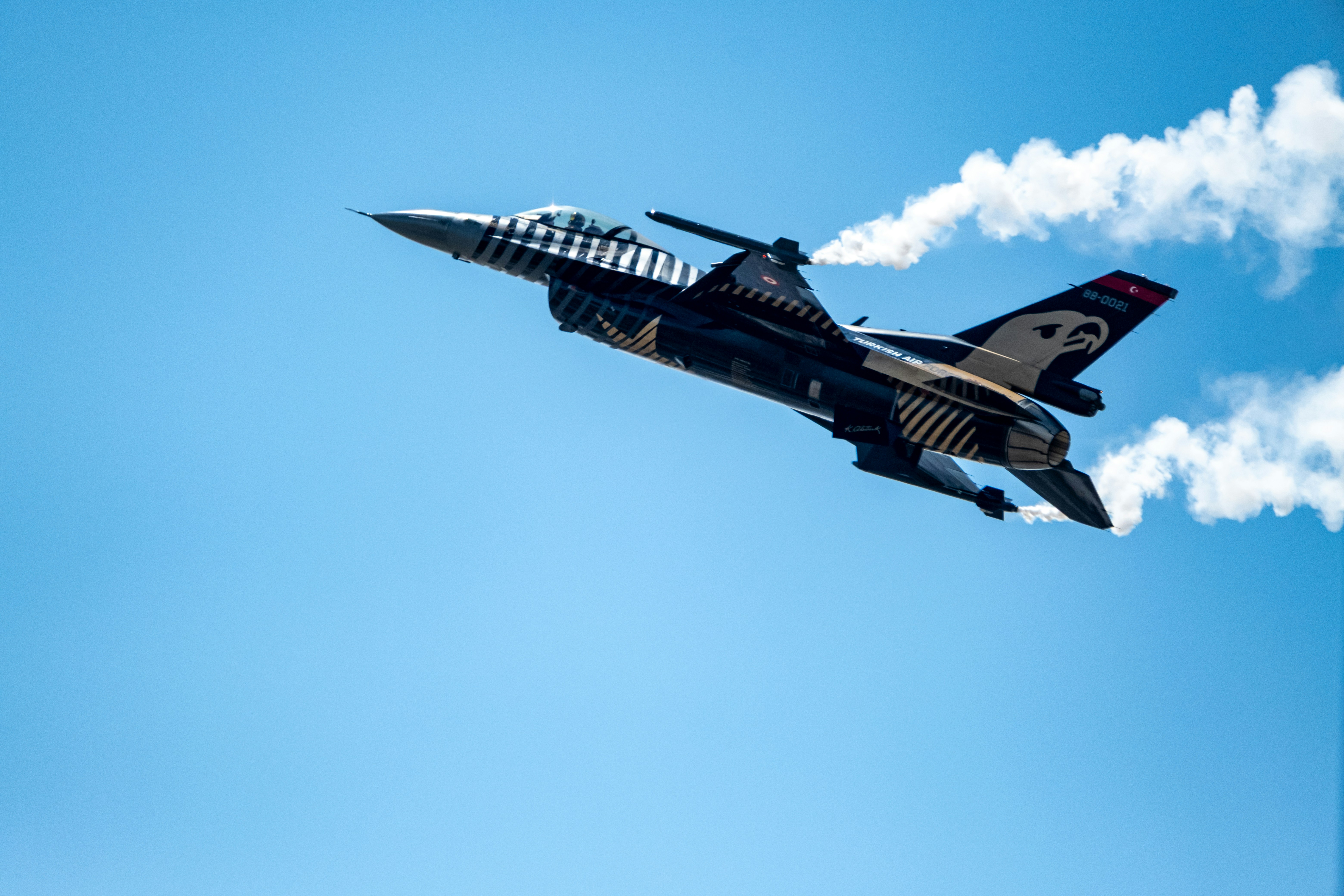 Contrail Dominance: A Striped Fighter Claws Through a Clear Sky