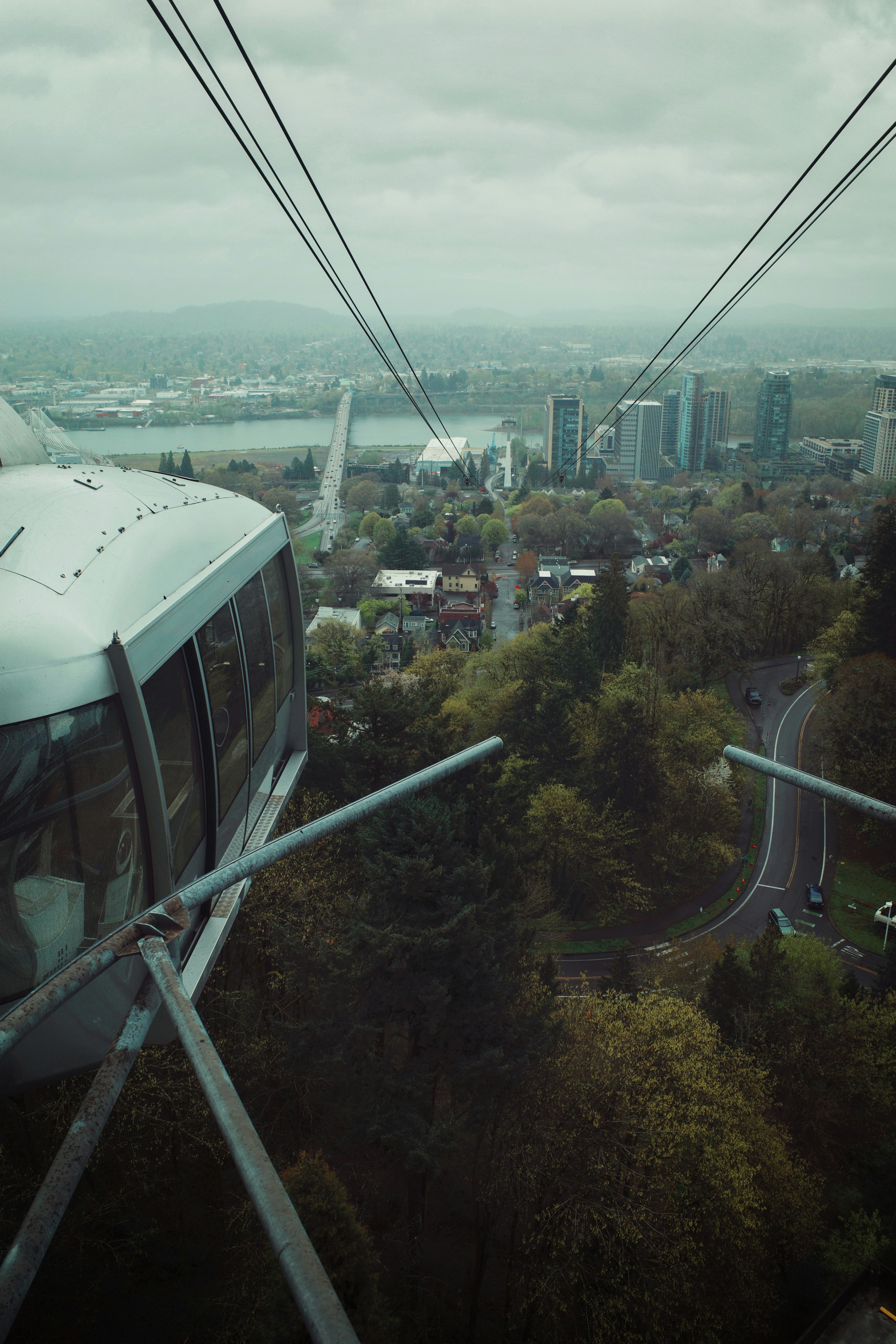 Ridge Line: Aerial Cable Car Slicing Through City and Forest