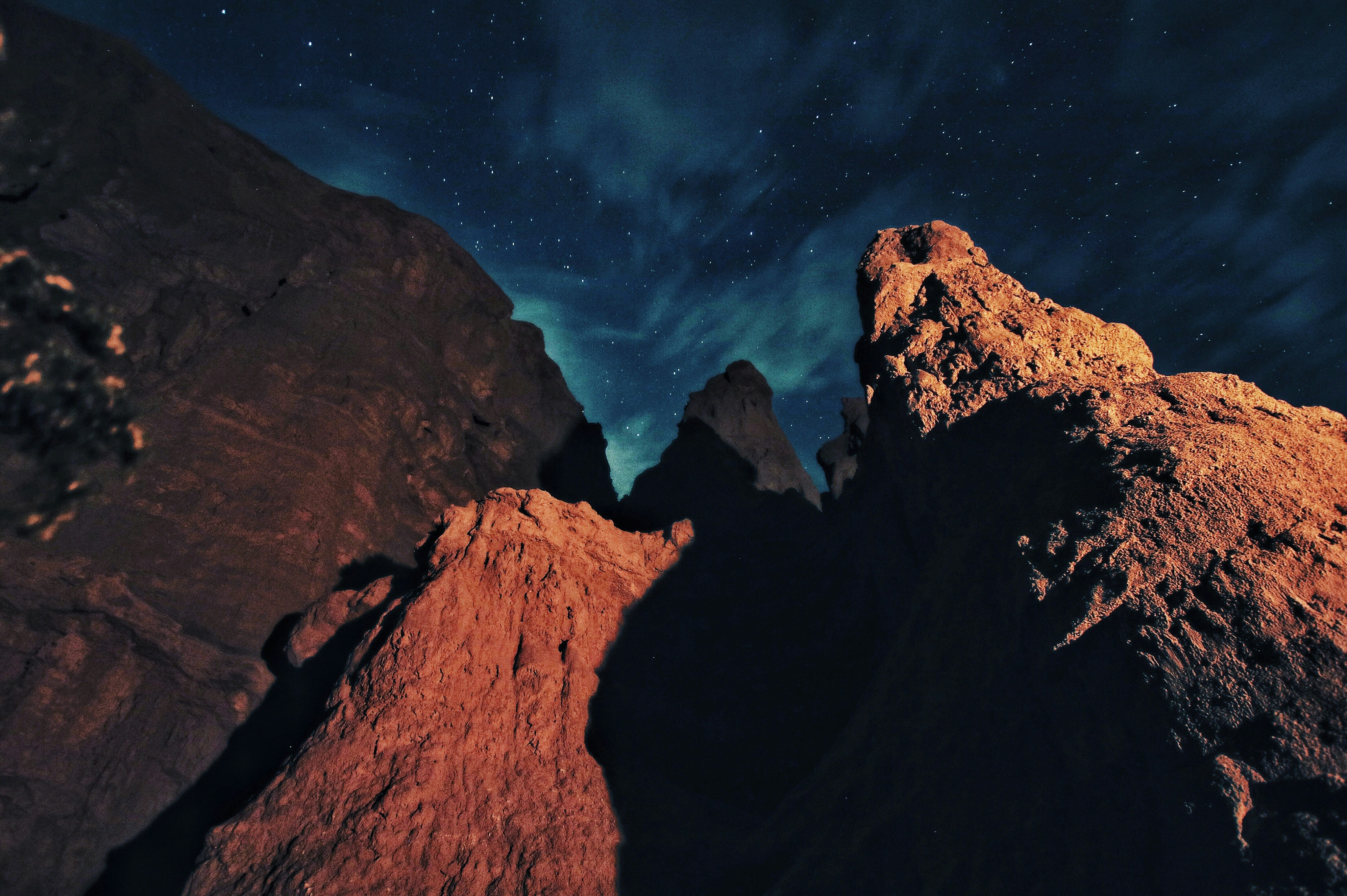 Moonlit Ridge: A Nighttime Clash of Rock and Sky
