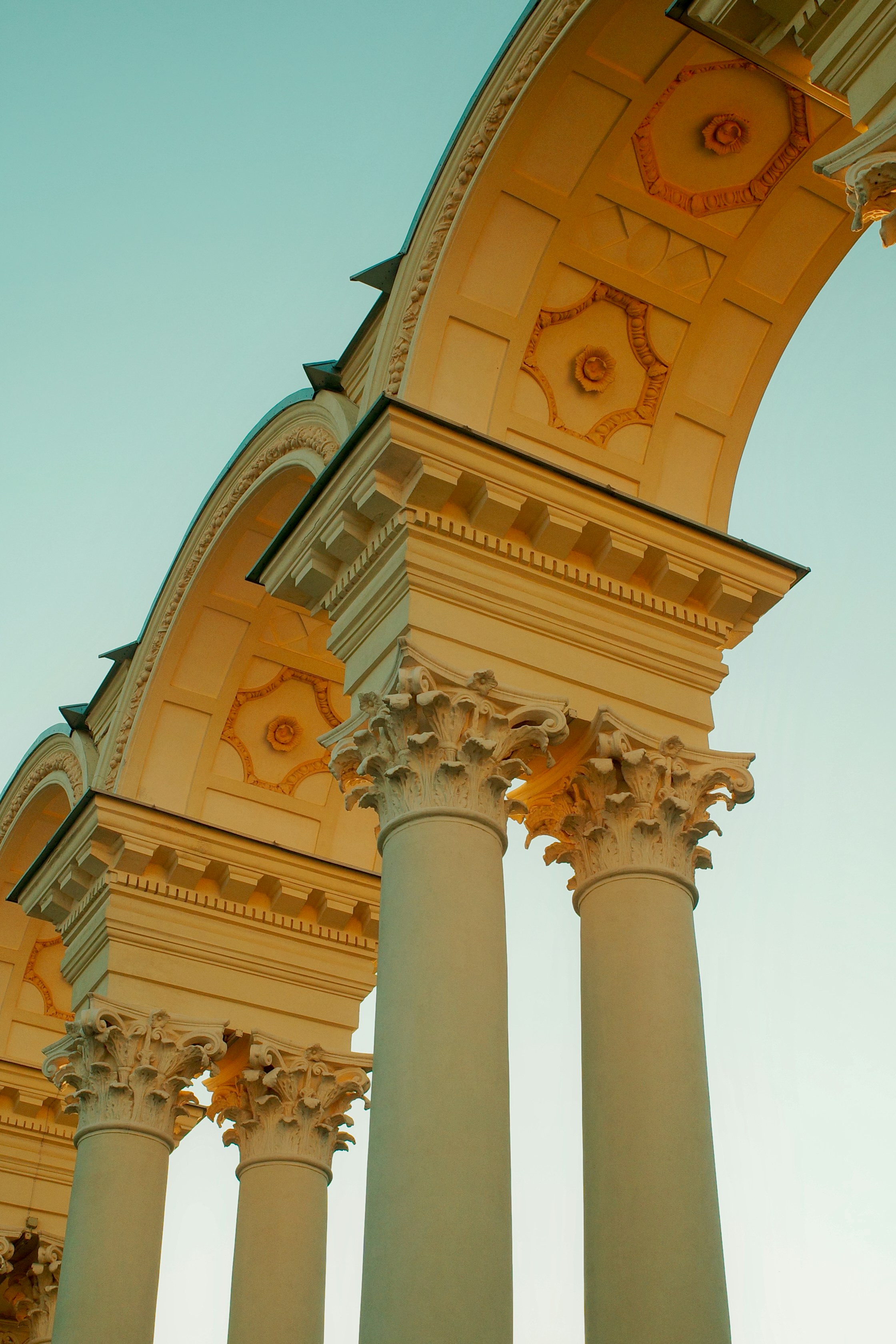 Sunlit Colonnade Archways Reach Toward a Clear Sky