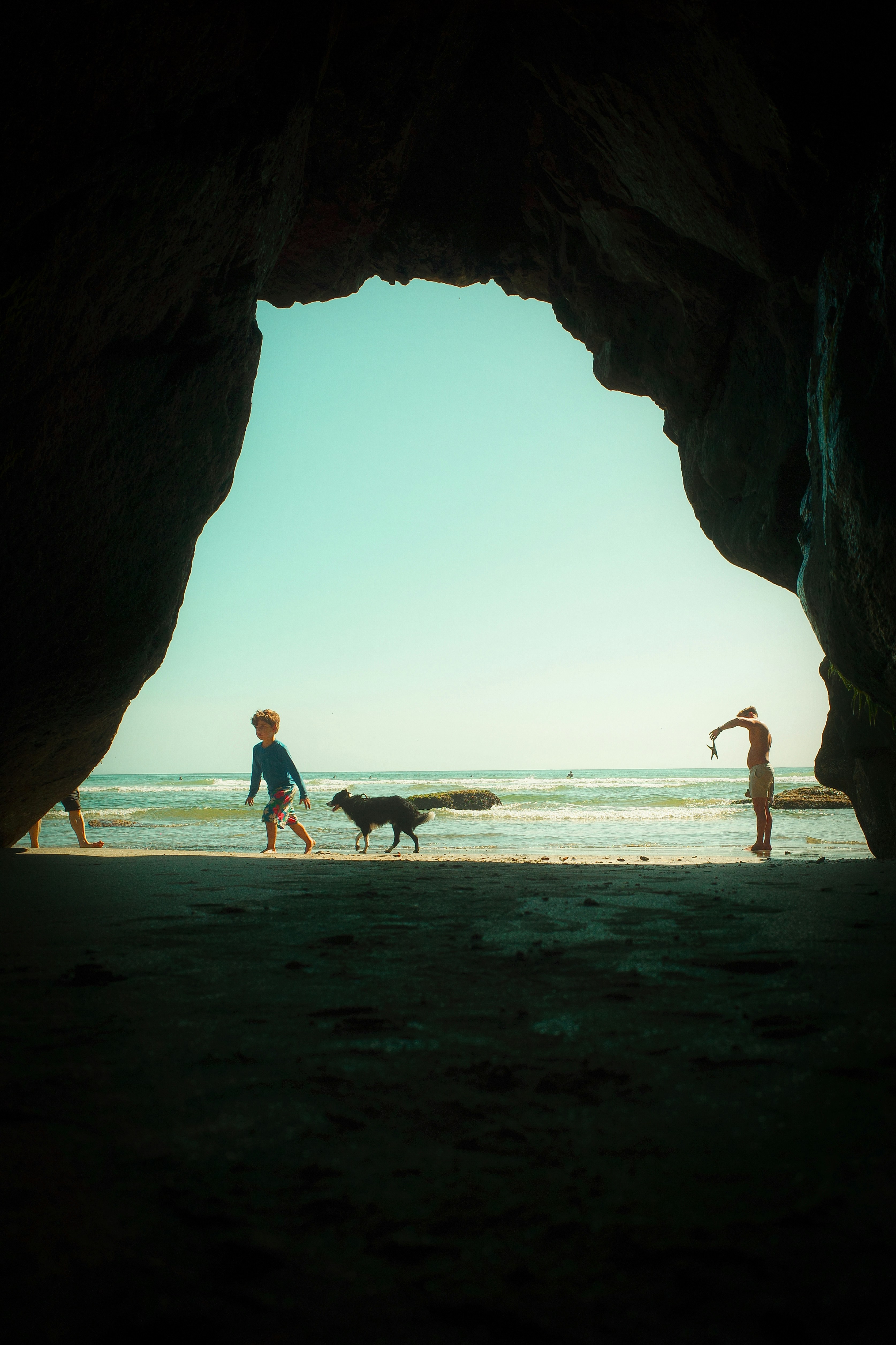 Cave Archway Framing a Sunny Beach Scene