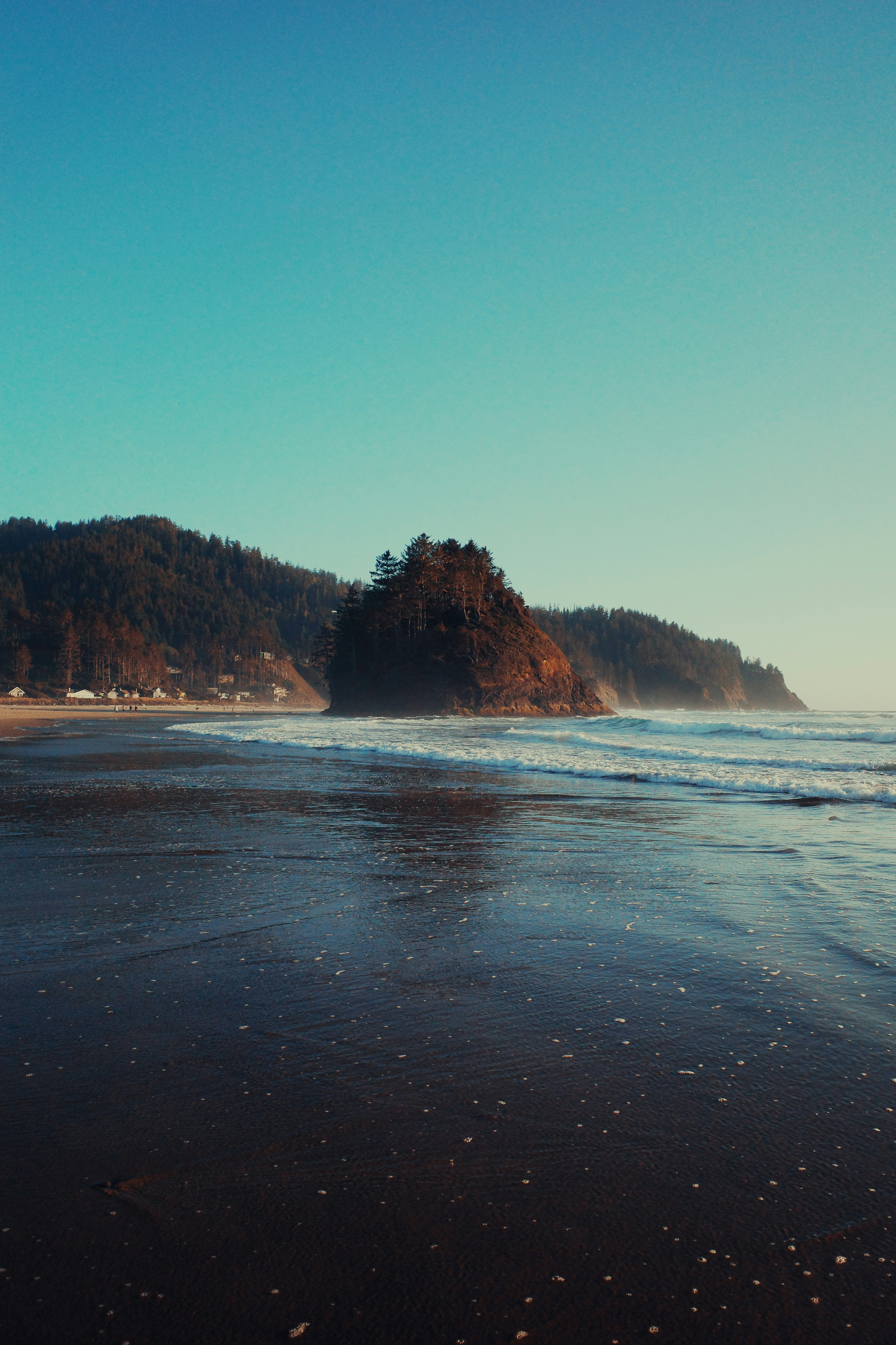 Sunlit Island Sentinel Amid Quiet Pacific Shore