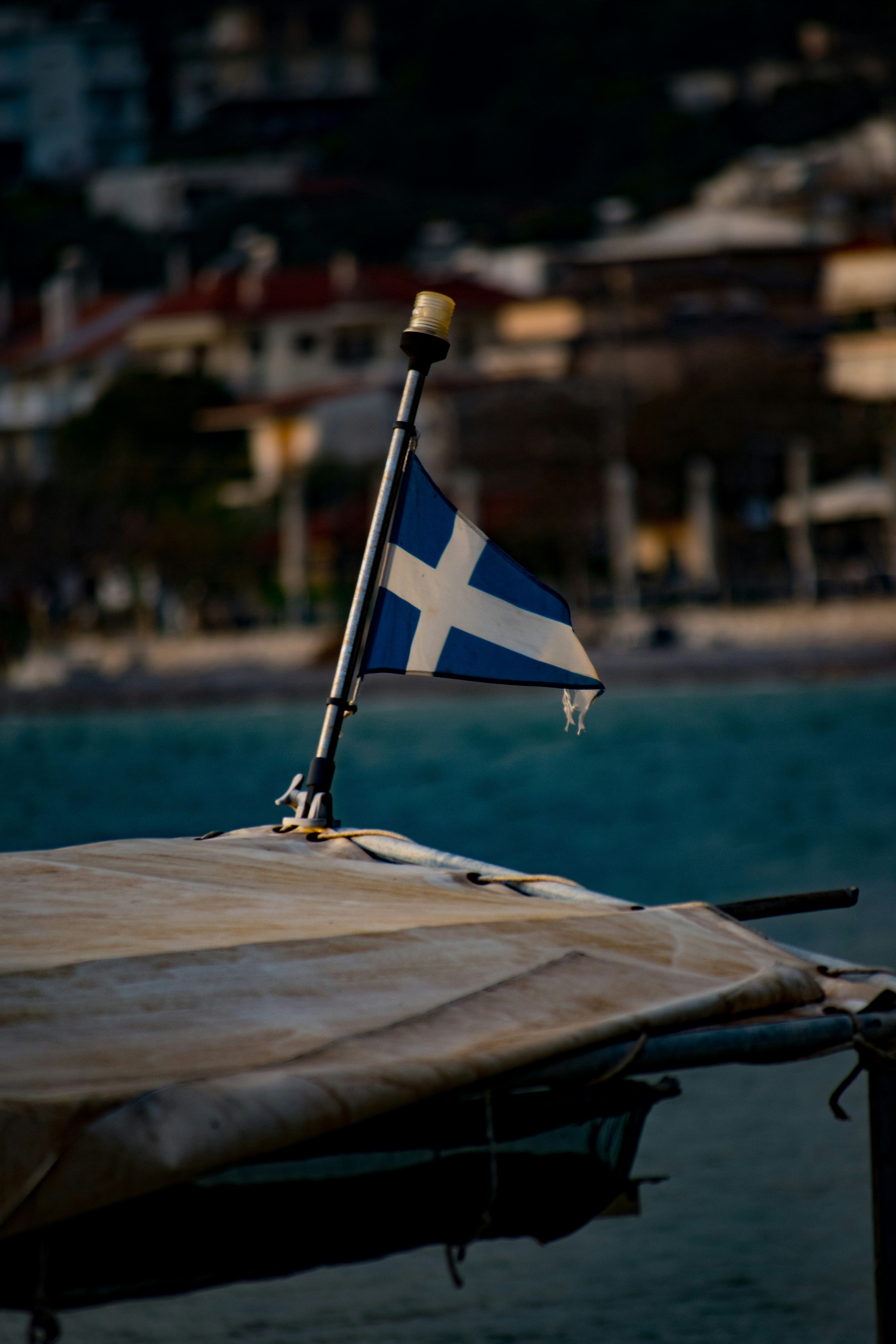 Flag on a Boat Mast: A Quiet Moment by the Shore