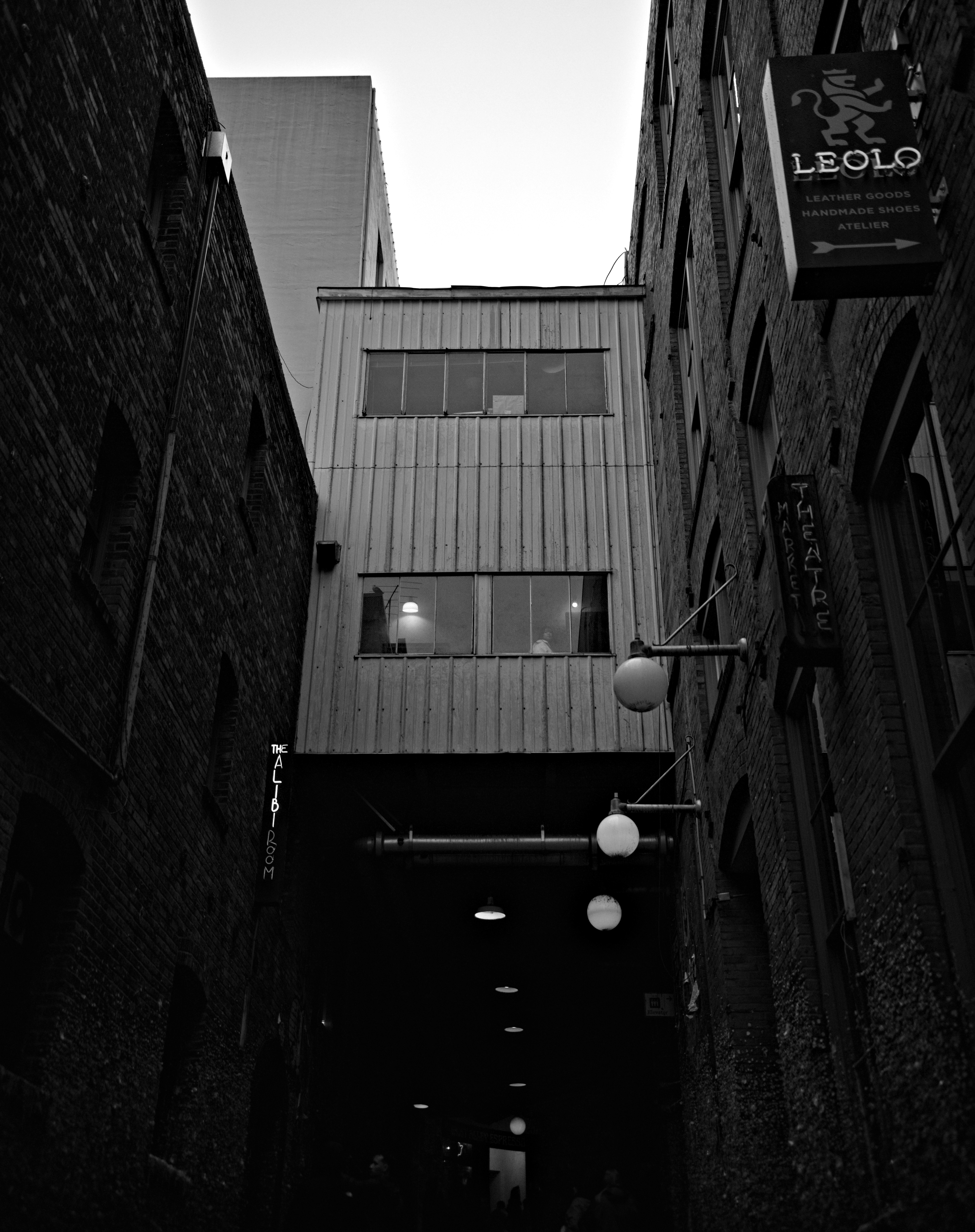 Urban Canyon: Lighted Archway Through Brick Walls