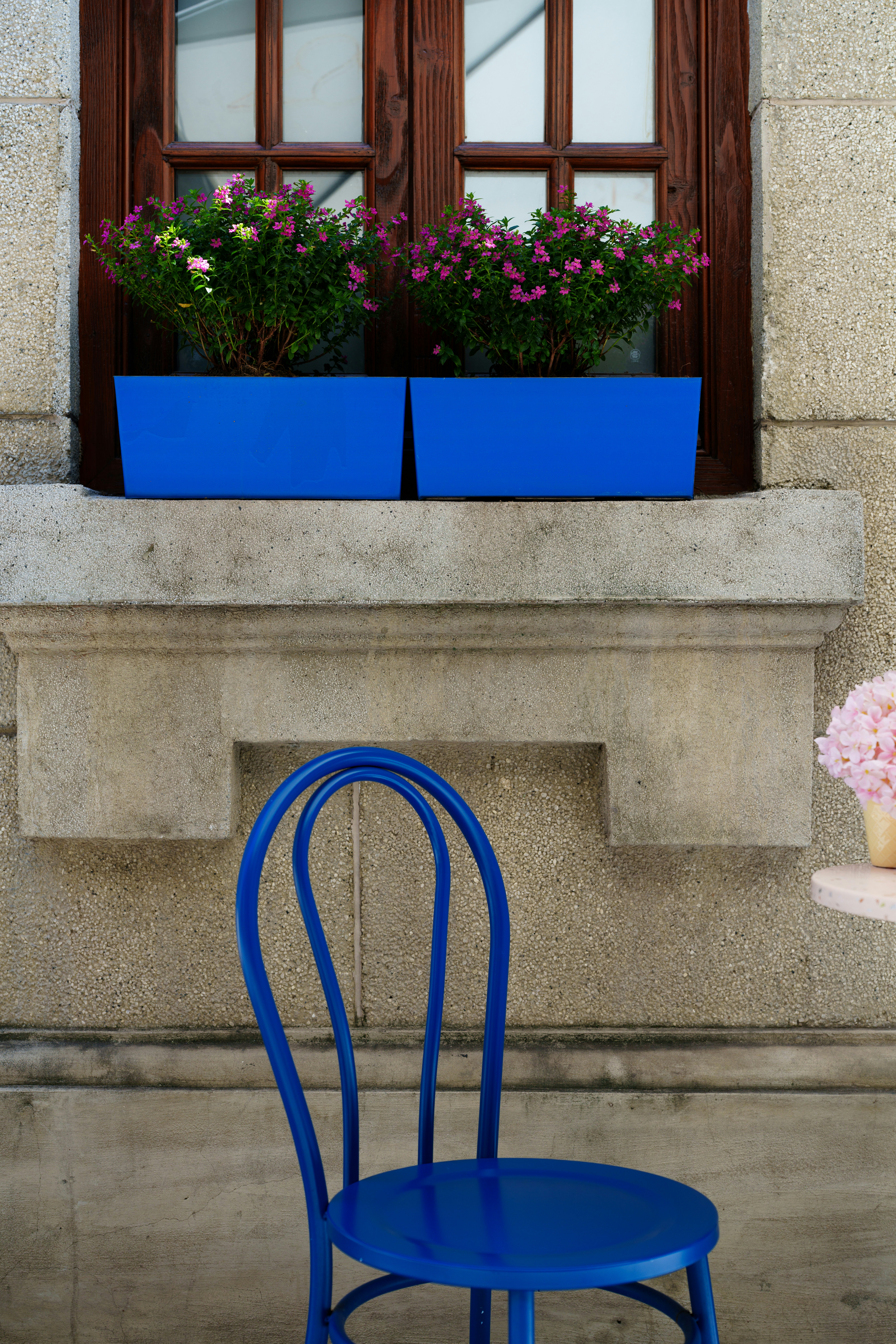 Blue Chair in Front of Window Planters