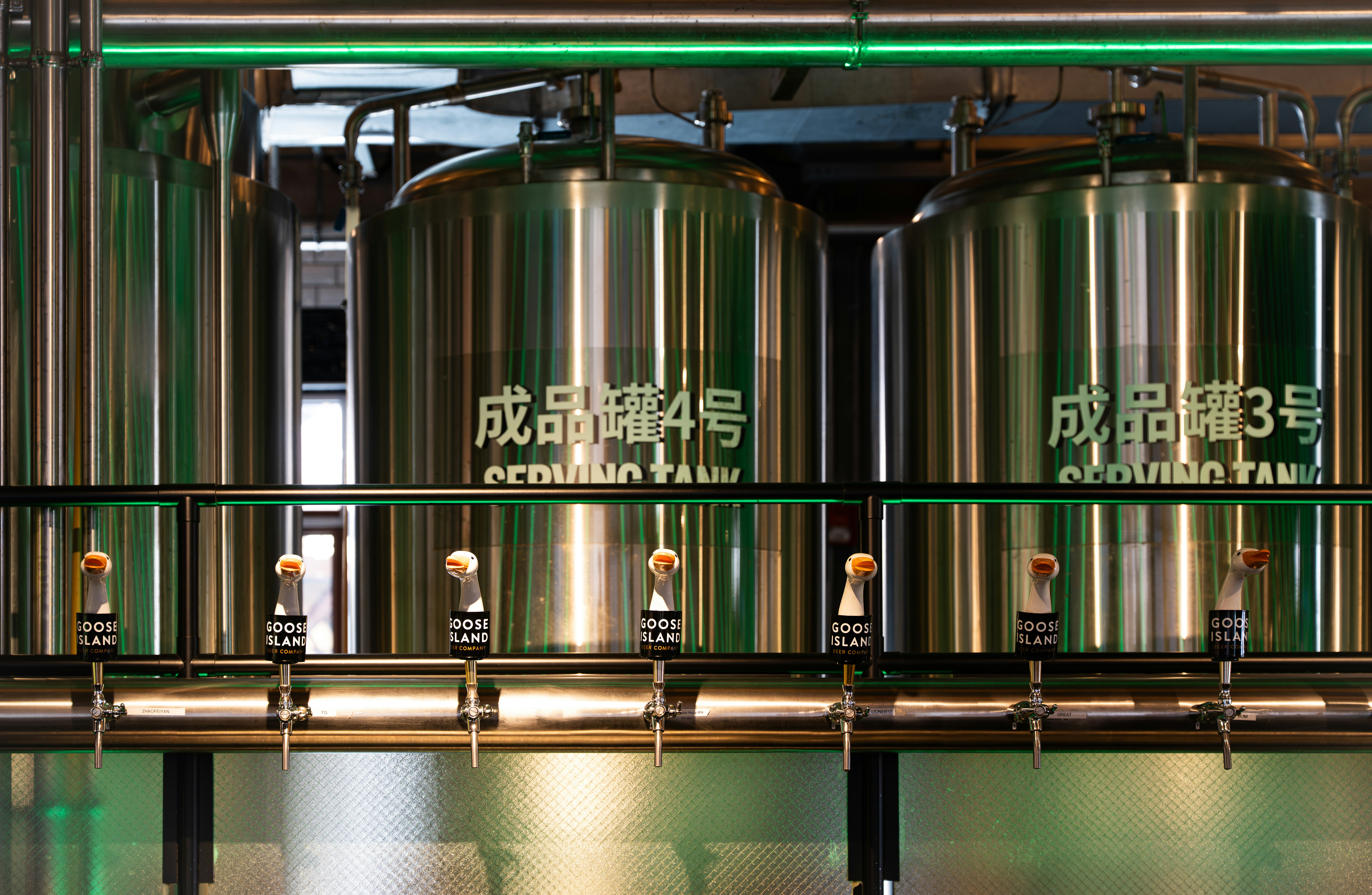 Reflective Stainless Cylinders in a Brewery Corridor