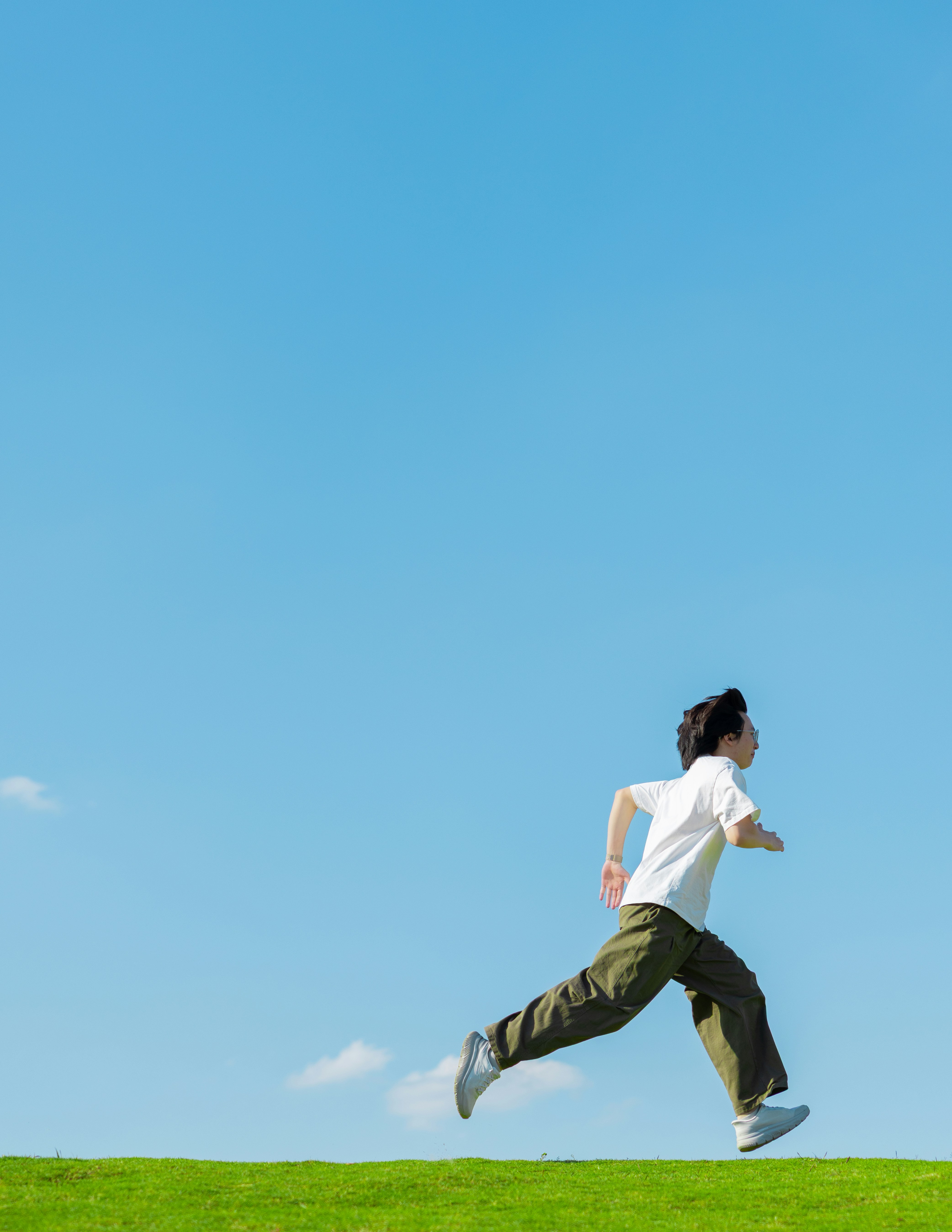 Leaping silhouette against a boundless blue canvas