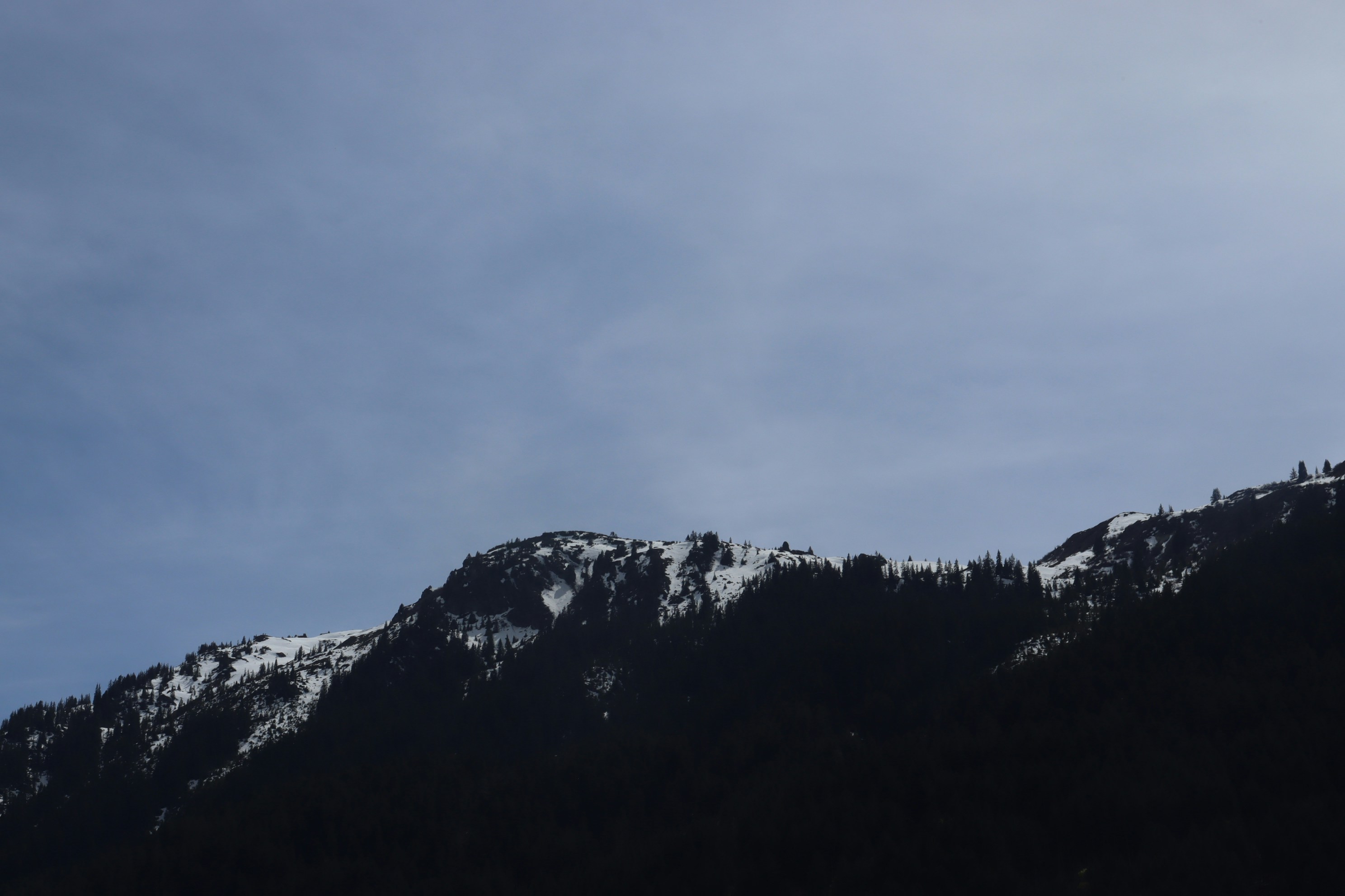 Snow-dusted ridge beneath a quiet sky