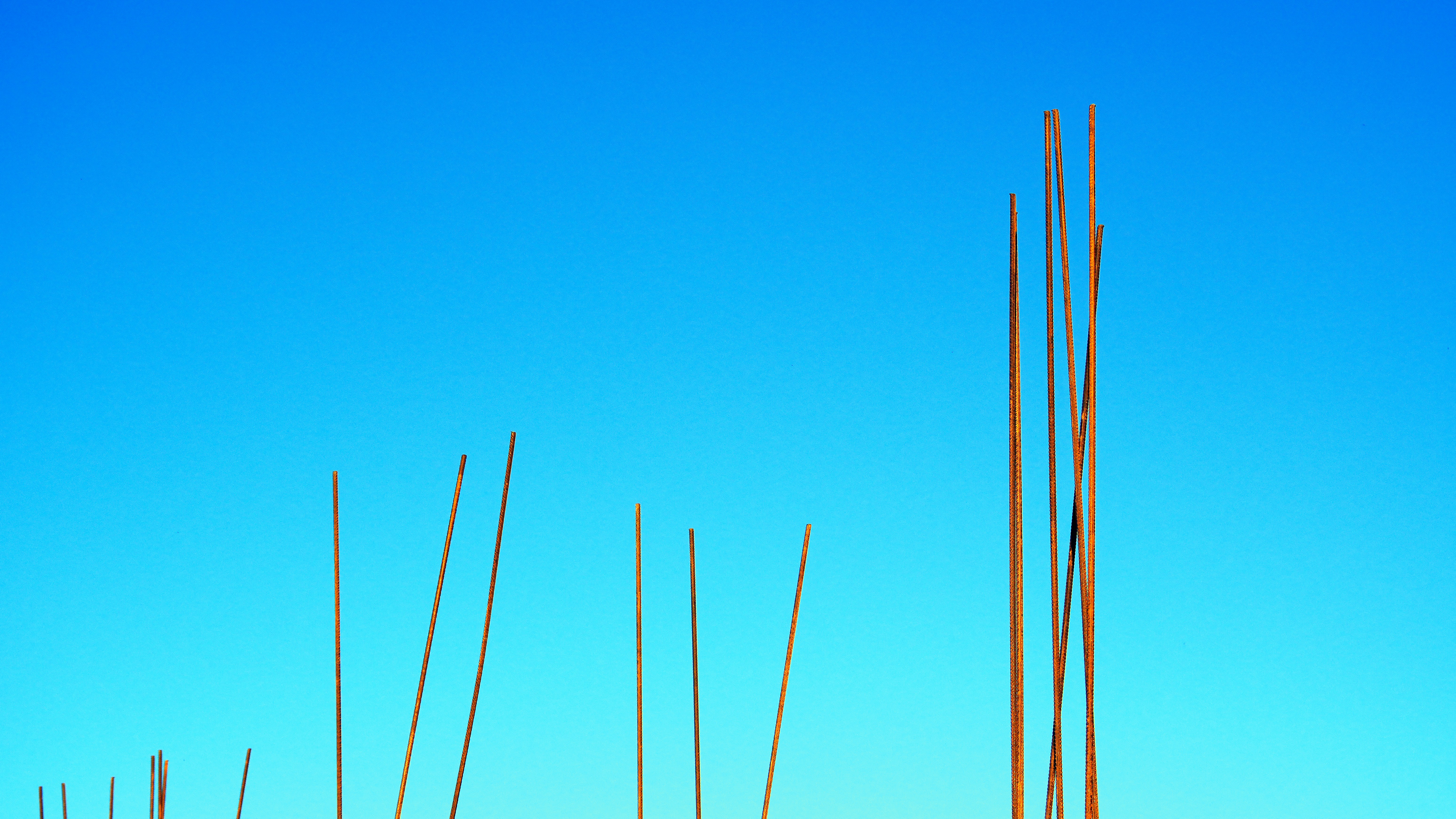 Vertical Rods Reaching toward a Cerulean Sky