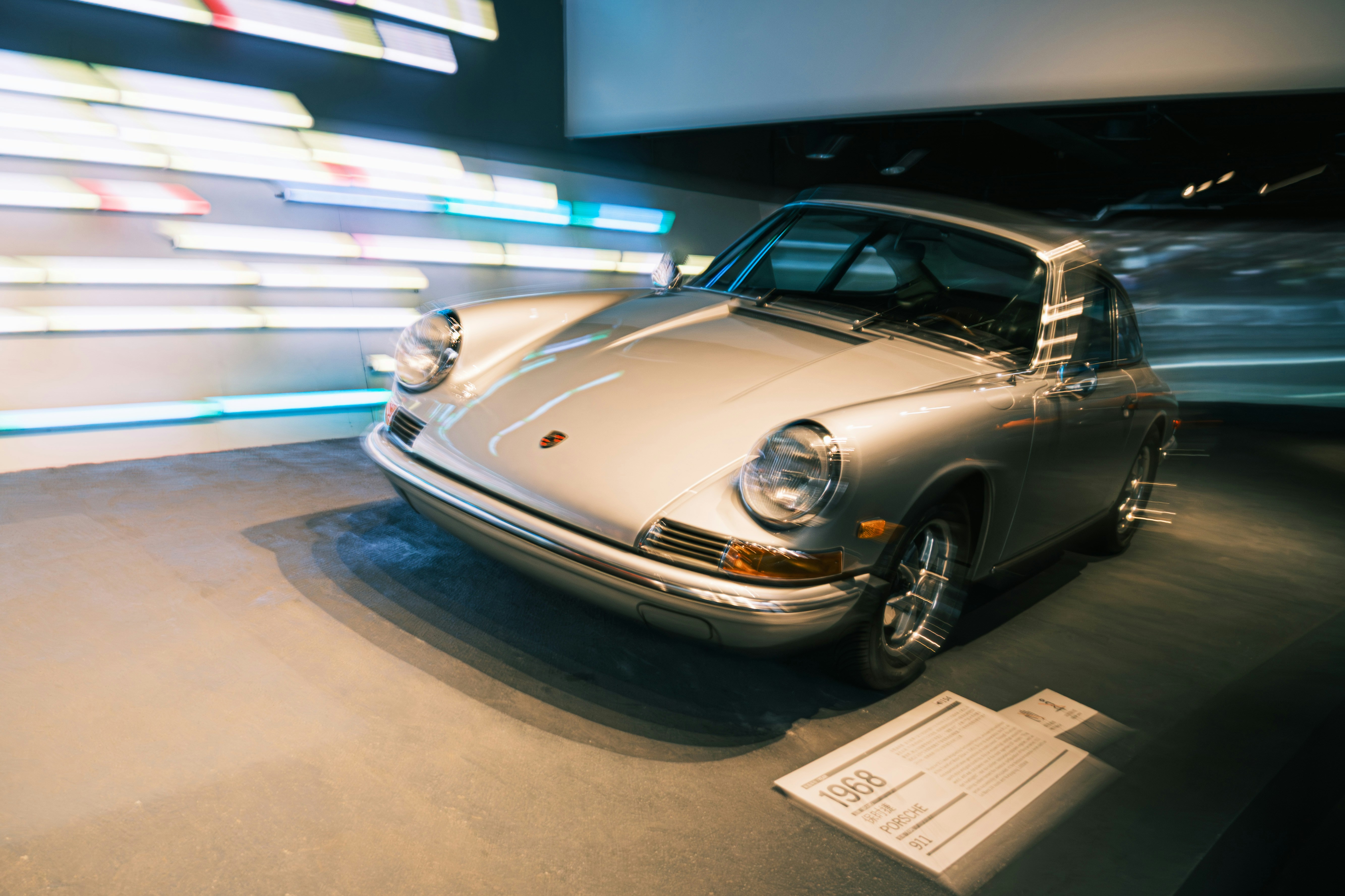 Vintage Porsche in motion: chrome curves under neon light