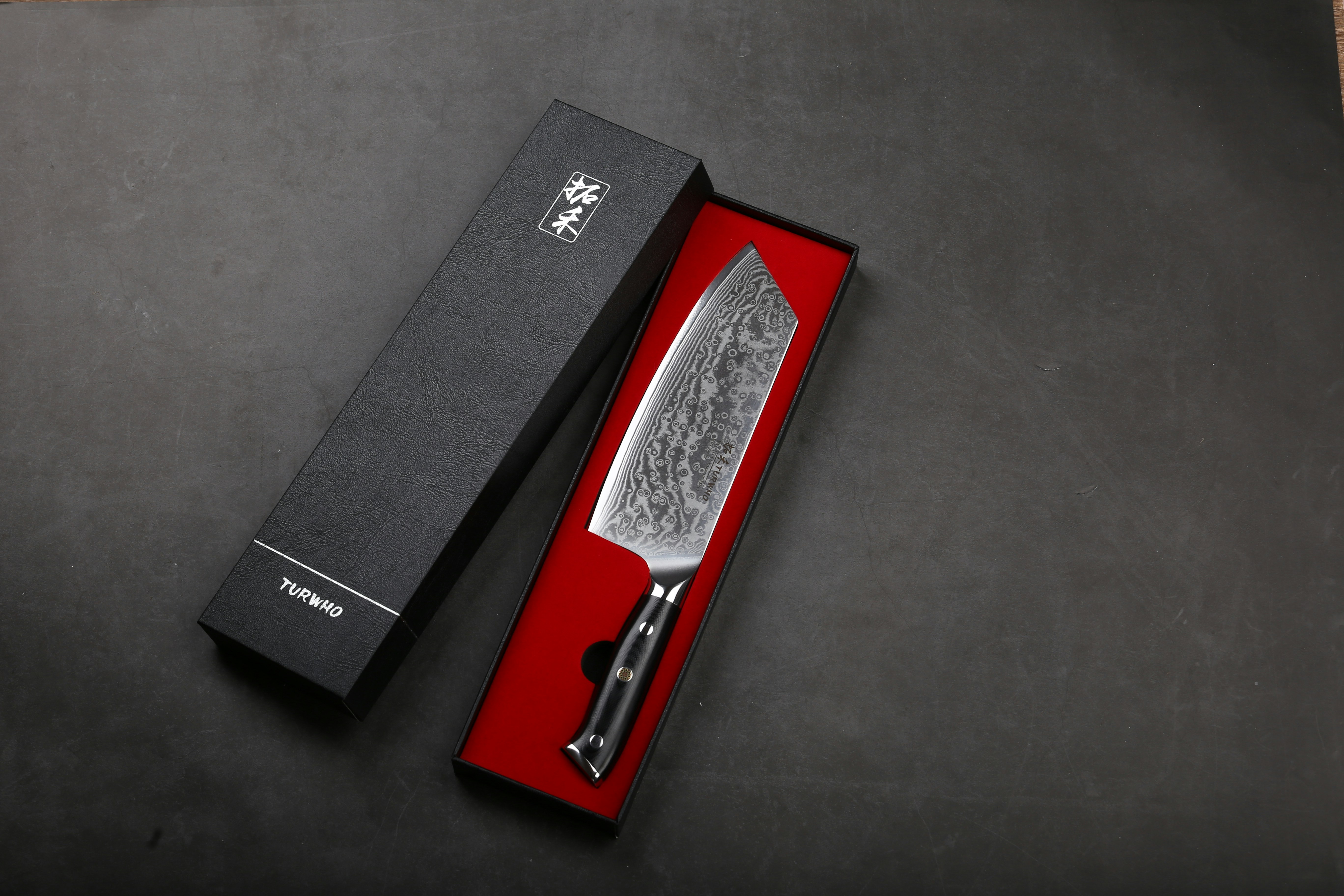Precise Craft: Damasteel Chef’s Knife Resting in Velvet Red