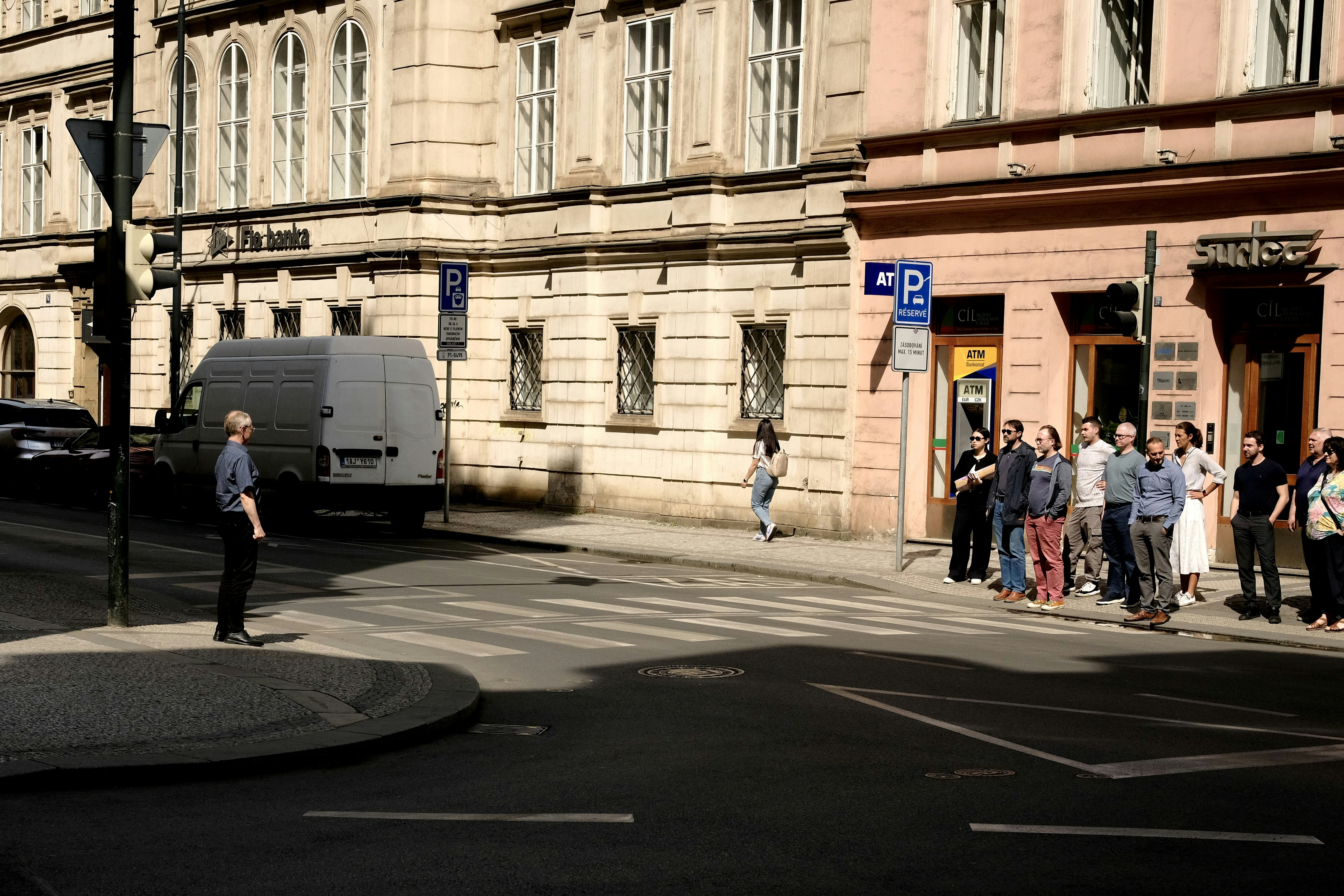 The Street Crossing: A Silent Parade of Pedestrians and a Waiting Van