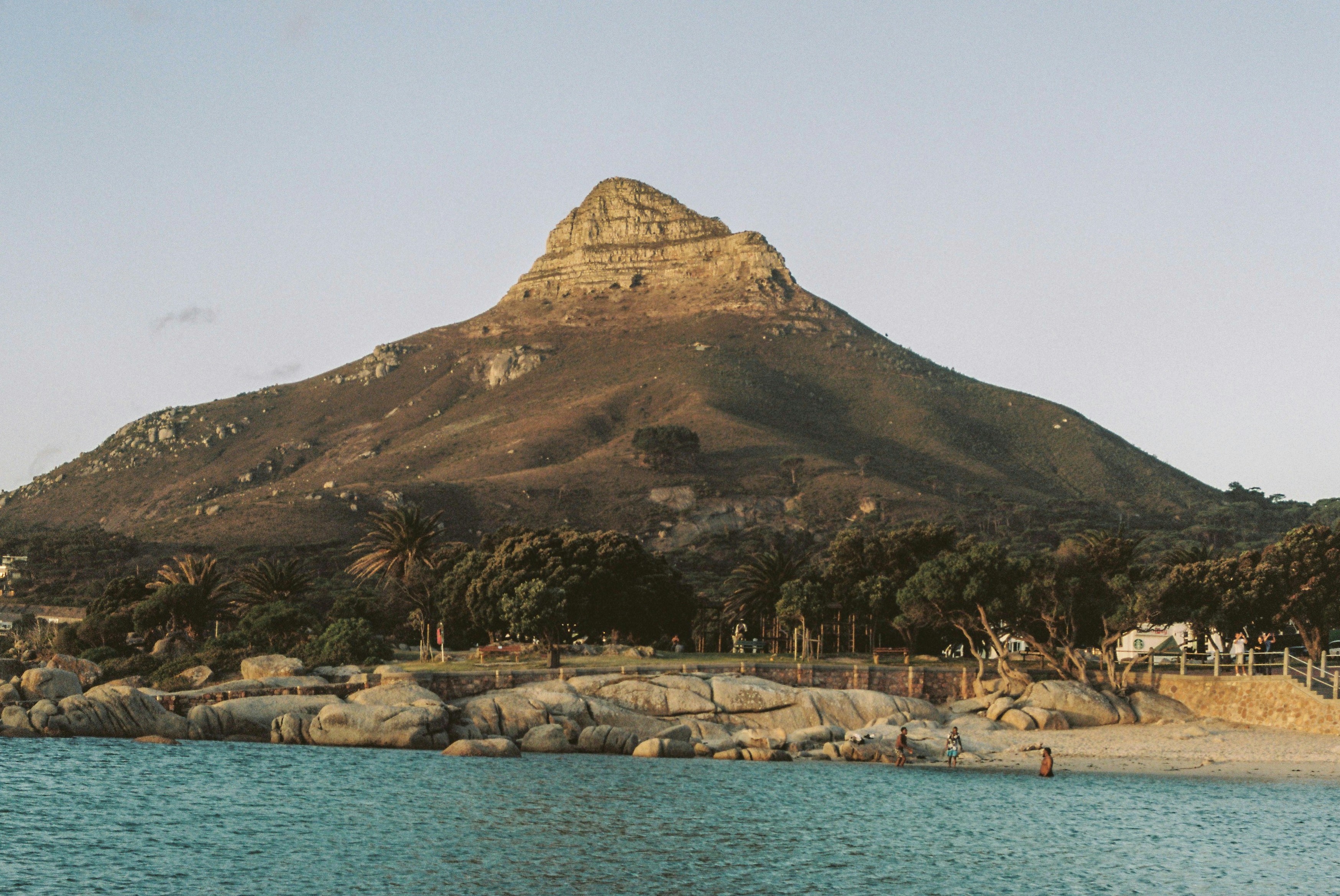 Coastal Pyramid: Mountain silhouette over a sunlit shoreline