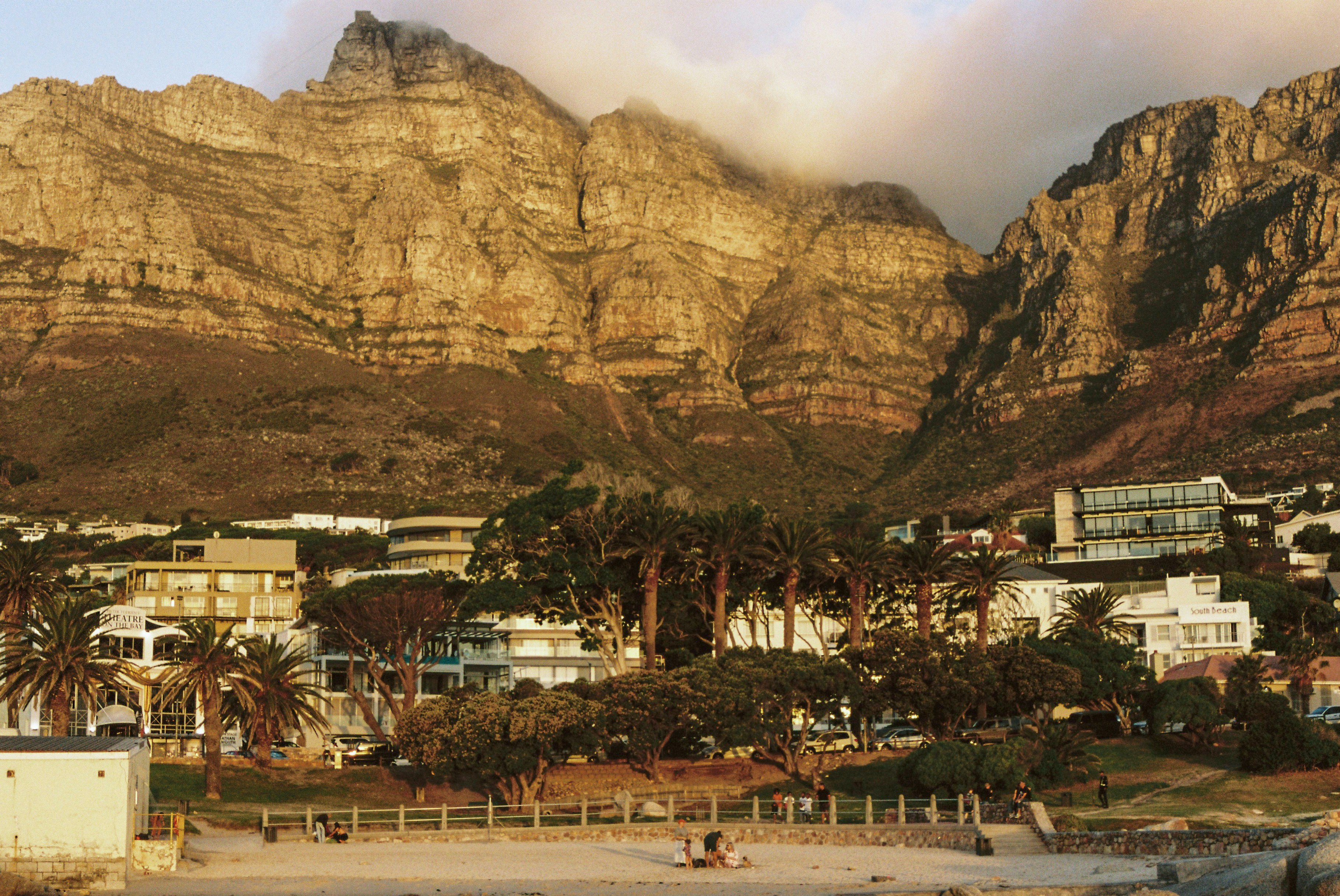 Coastal Town Beneath Mountain Majesty at Golden Hour