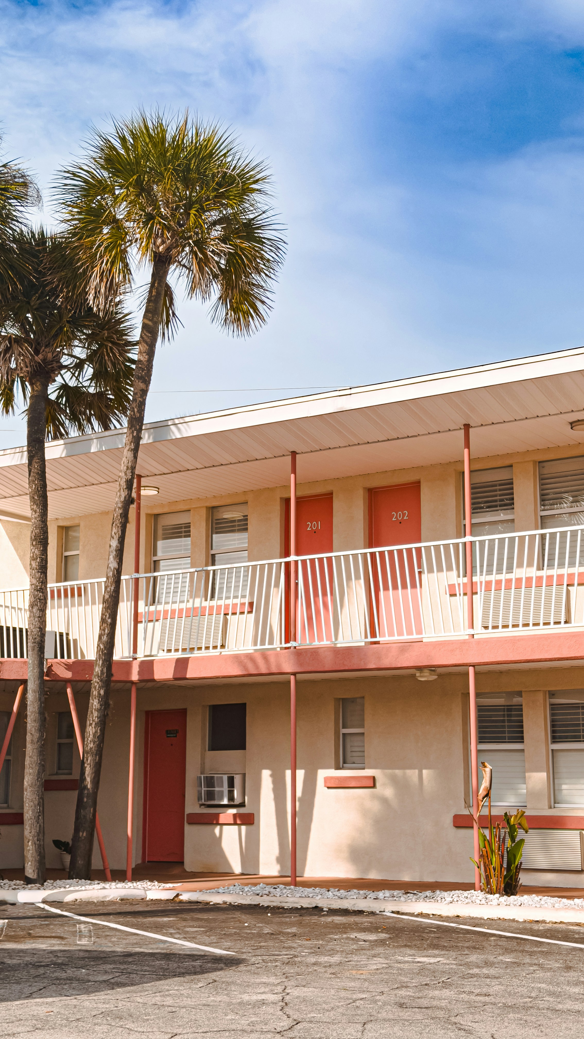 Mid-Century Motel Offramp: Palm Shadows Over a Two-Story Walkway