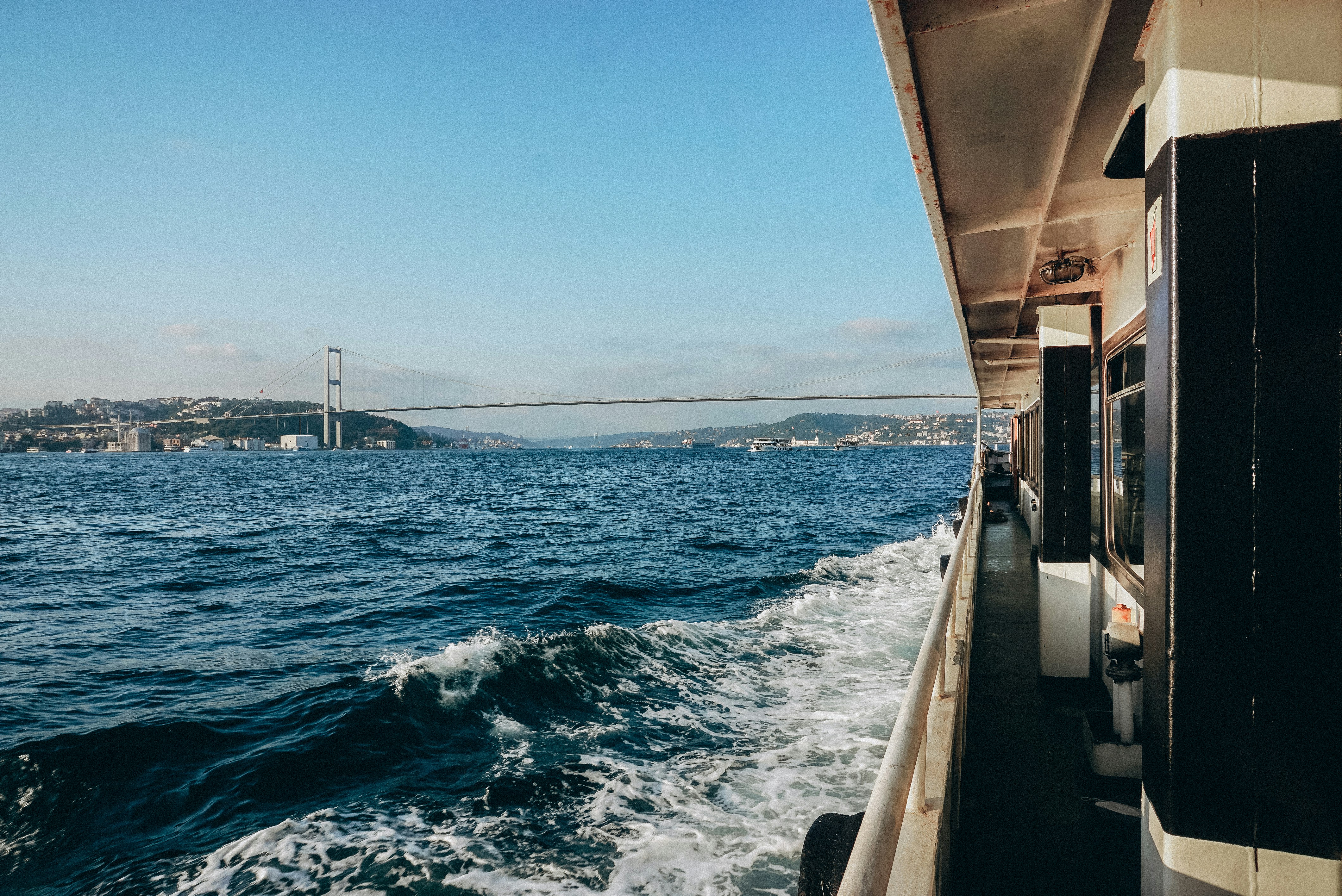 Onboard View: Horizon, Waves, and the Vessel’s Shadowed Deck