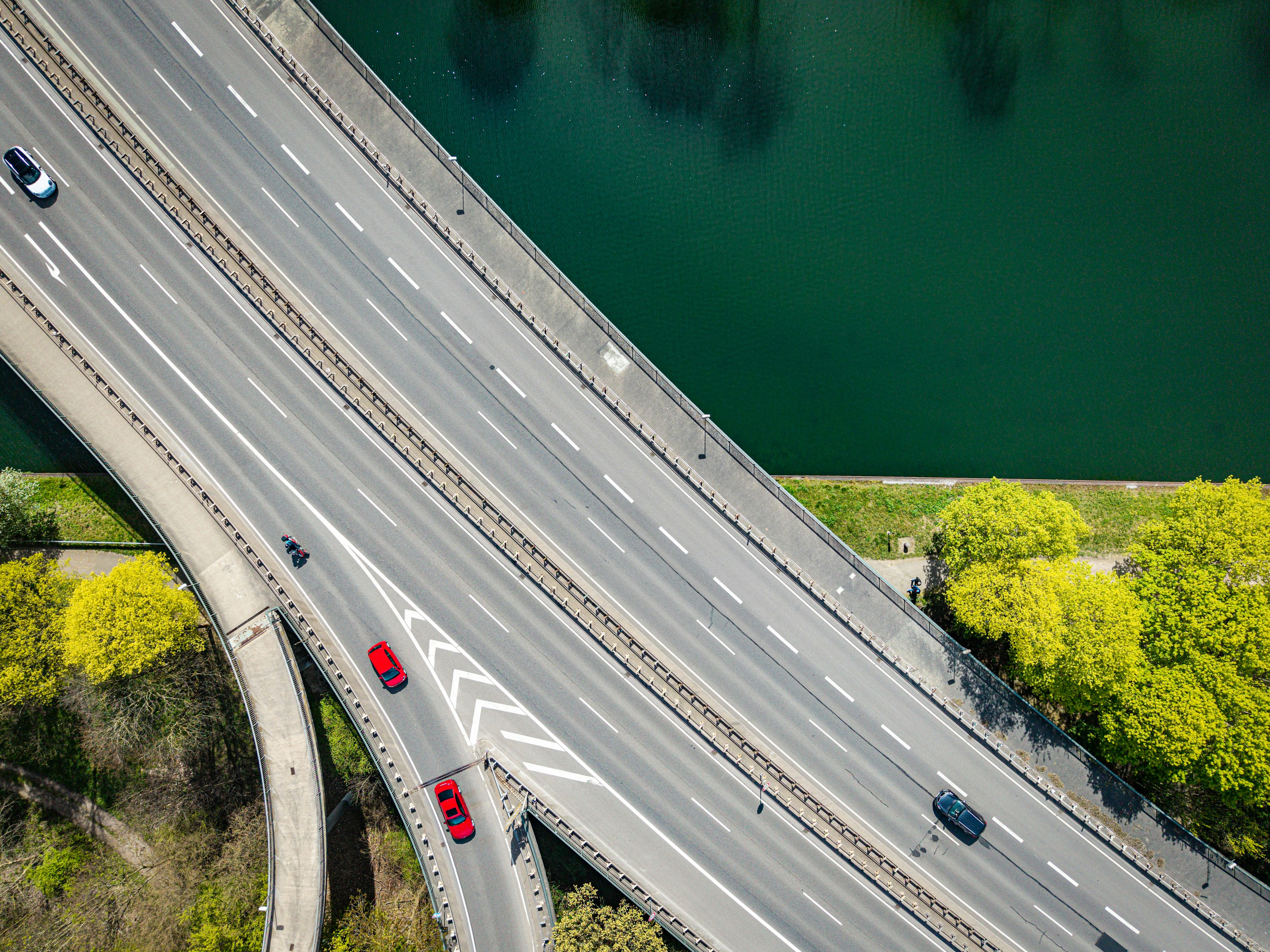 Overpass Spiral: Aerial View of a Winding Road Crossing a River