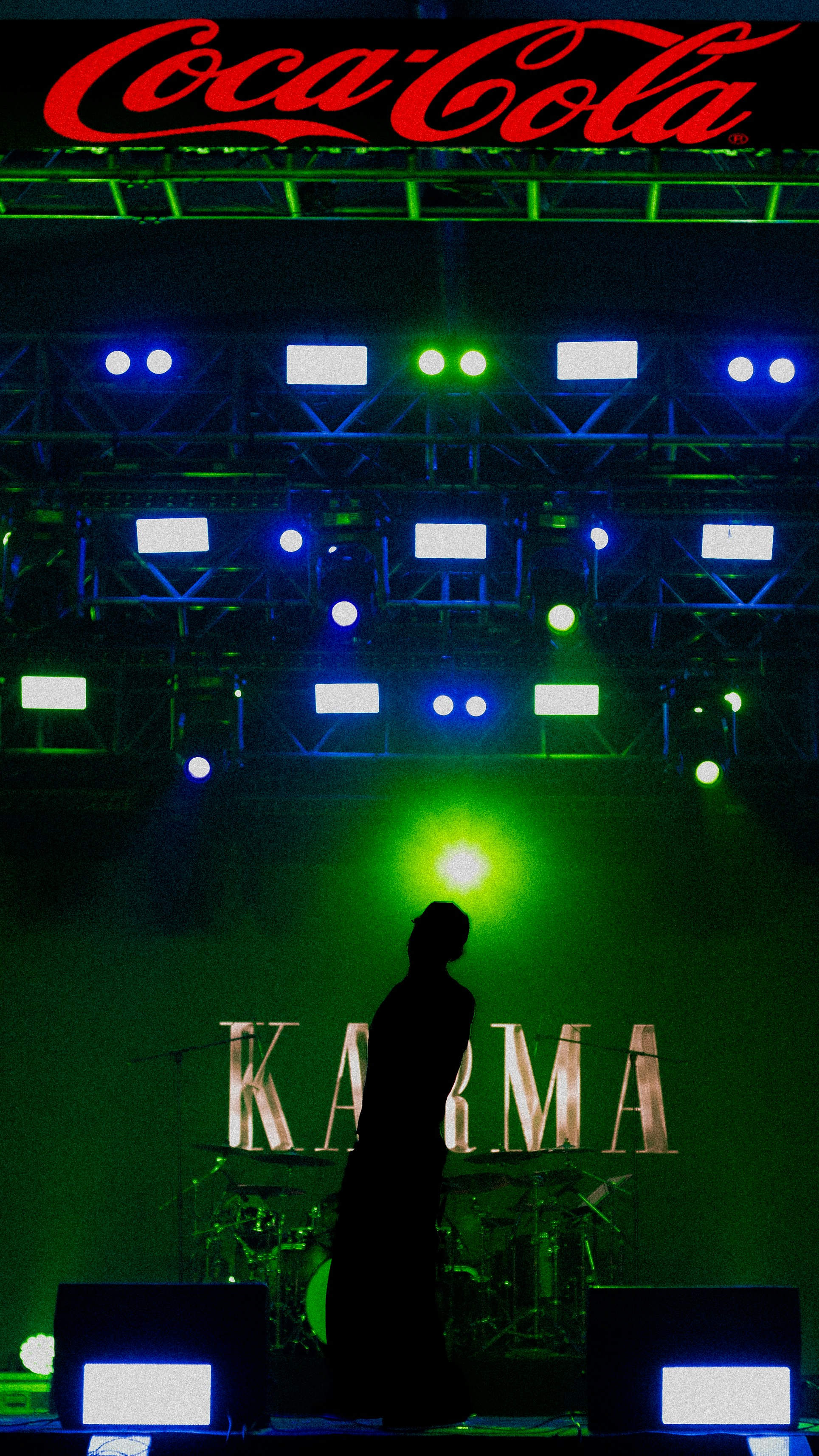 Silhouette Under Neon Lights: Karma’s Stage