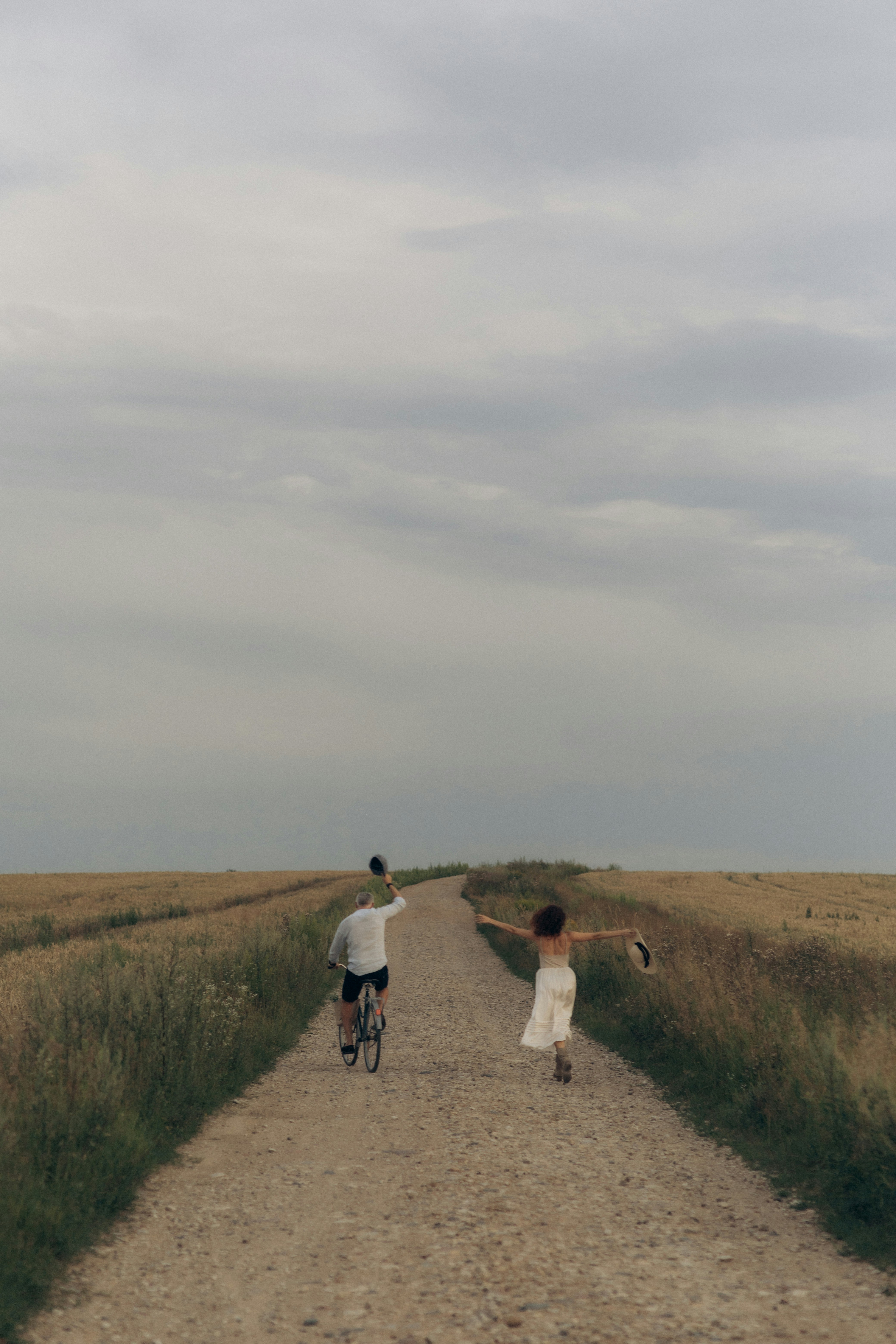 Two Figures on a Gravel Path toward a Quiet Horizon