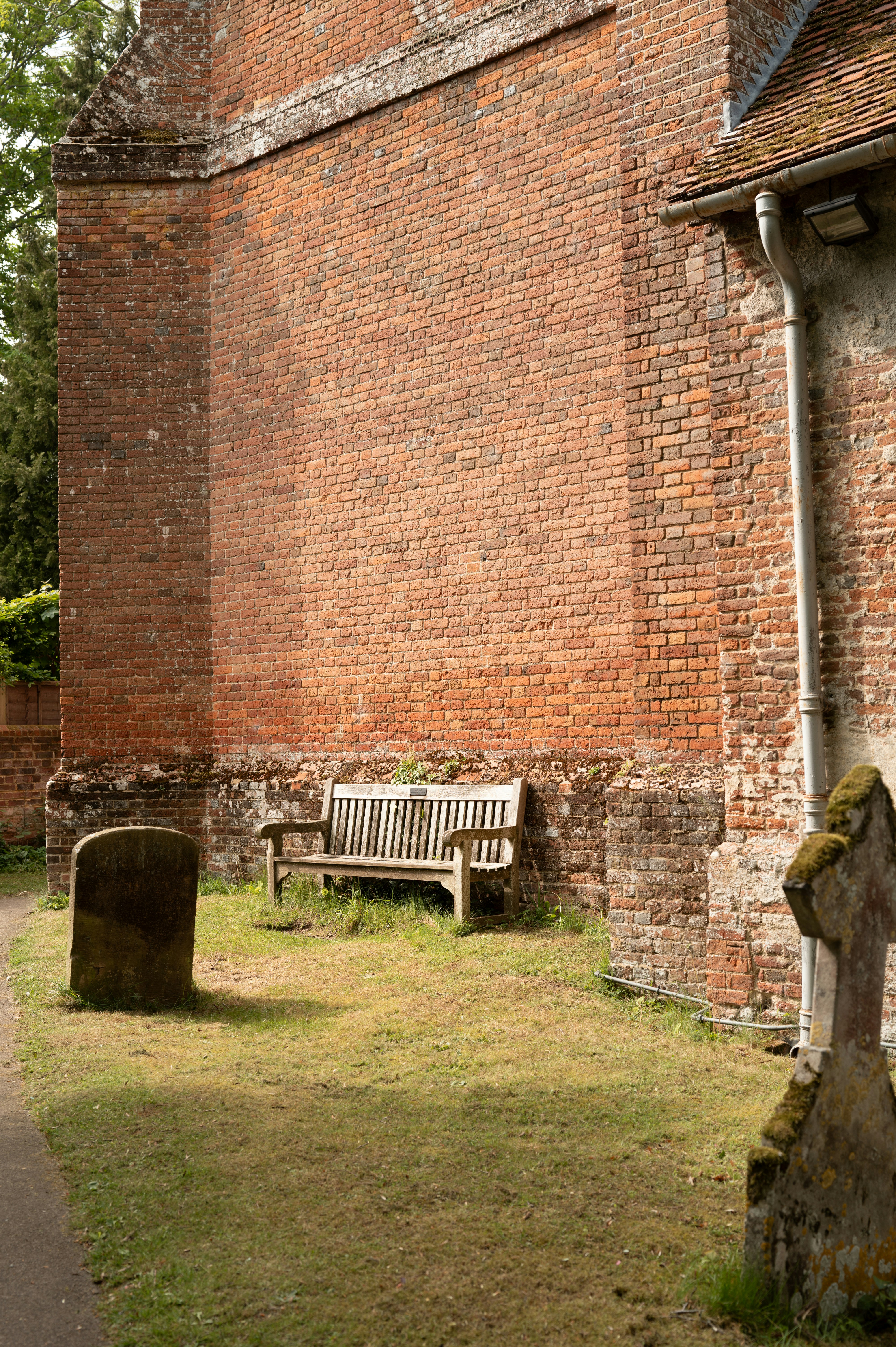 Bench Beneath a Brick Wall: Quiet Grounds of an Old Site