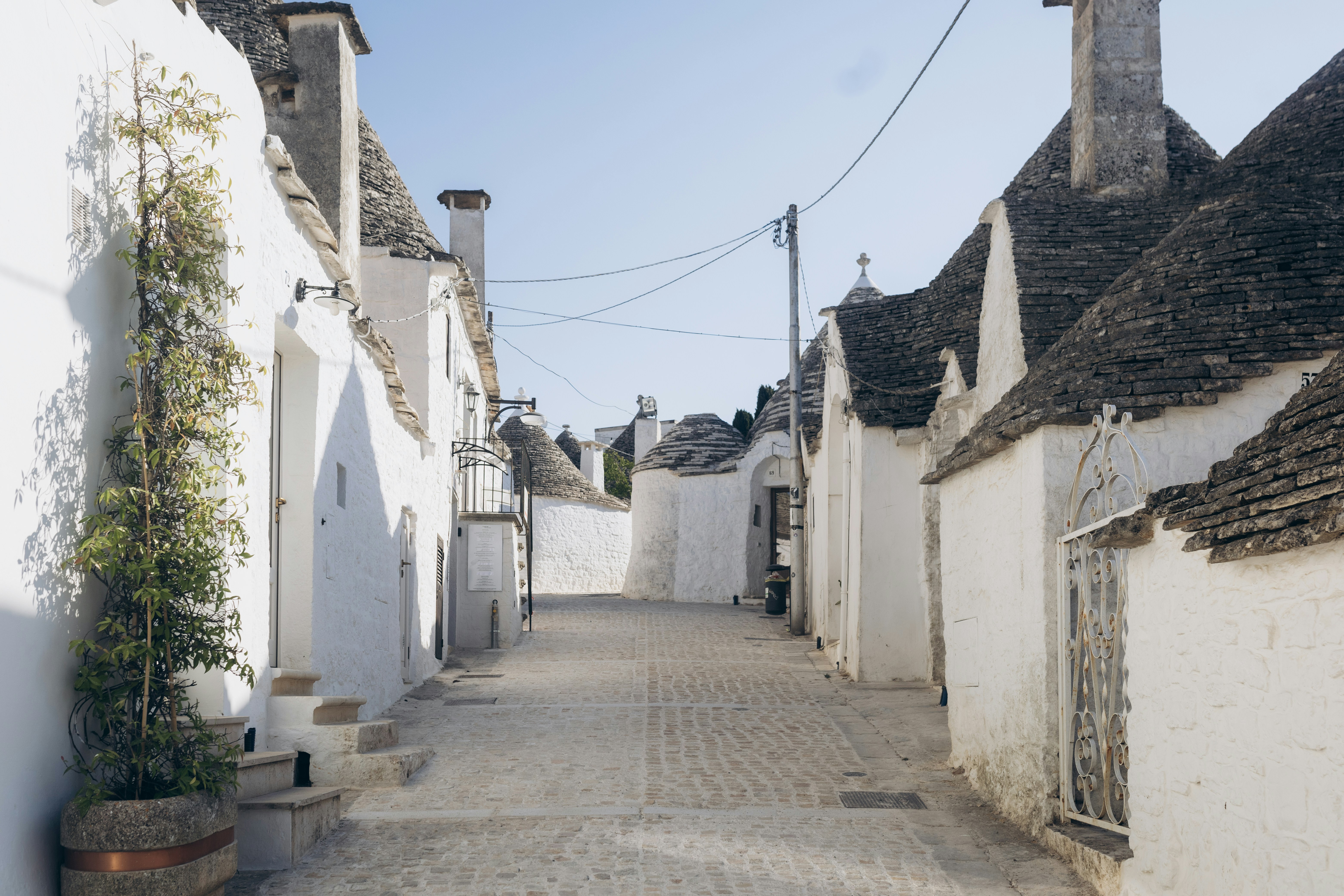 White-walled alleyway toward a sunlit horizon