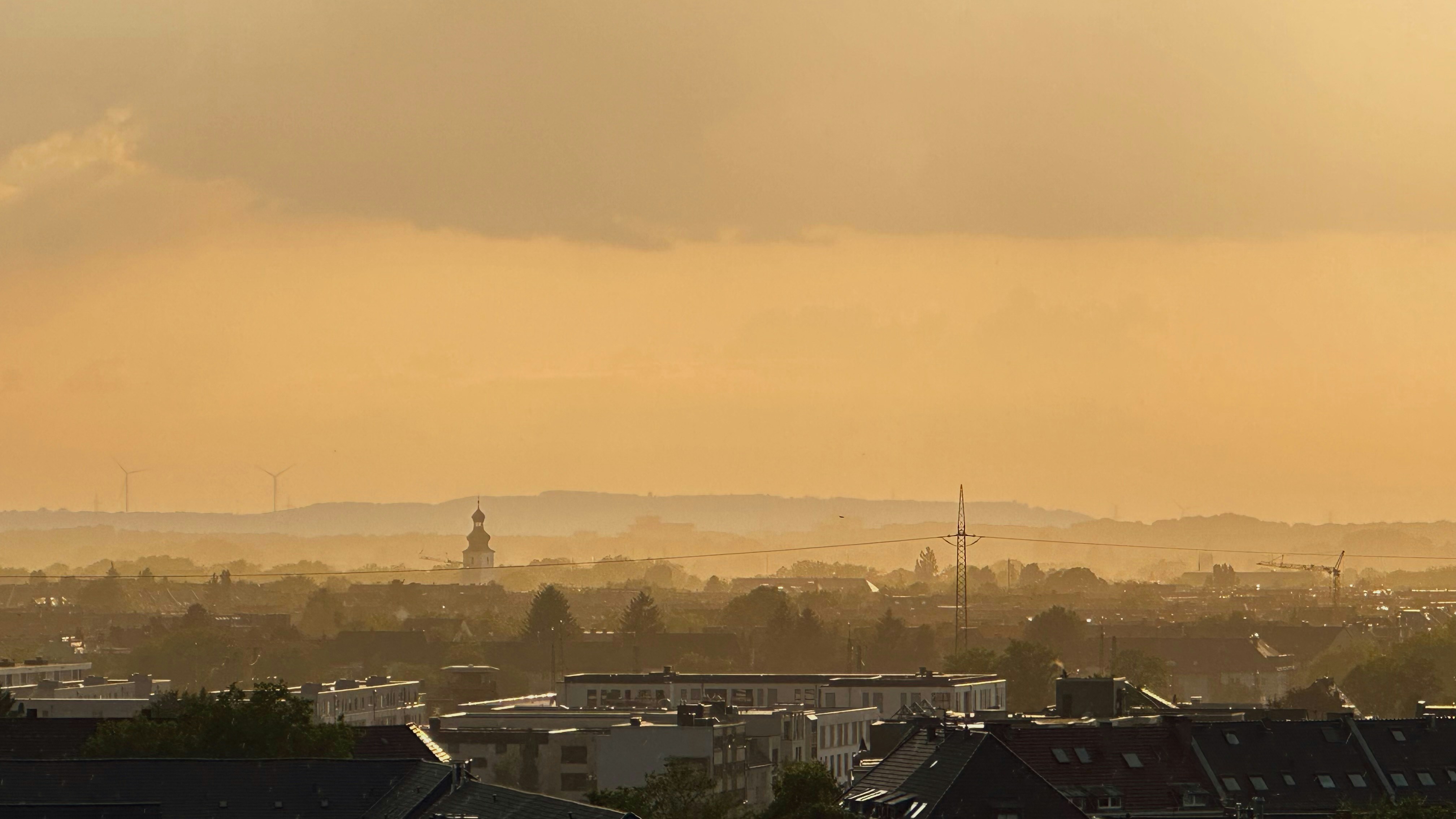 Distant Turrets and Tin Roofs: A Quiet City Horizon at Dusk