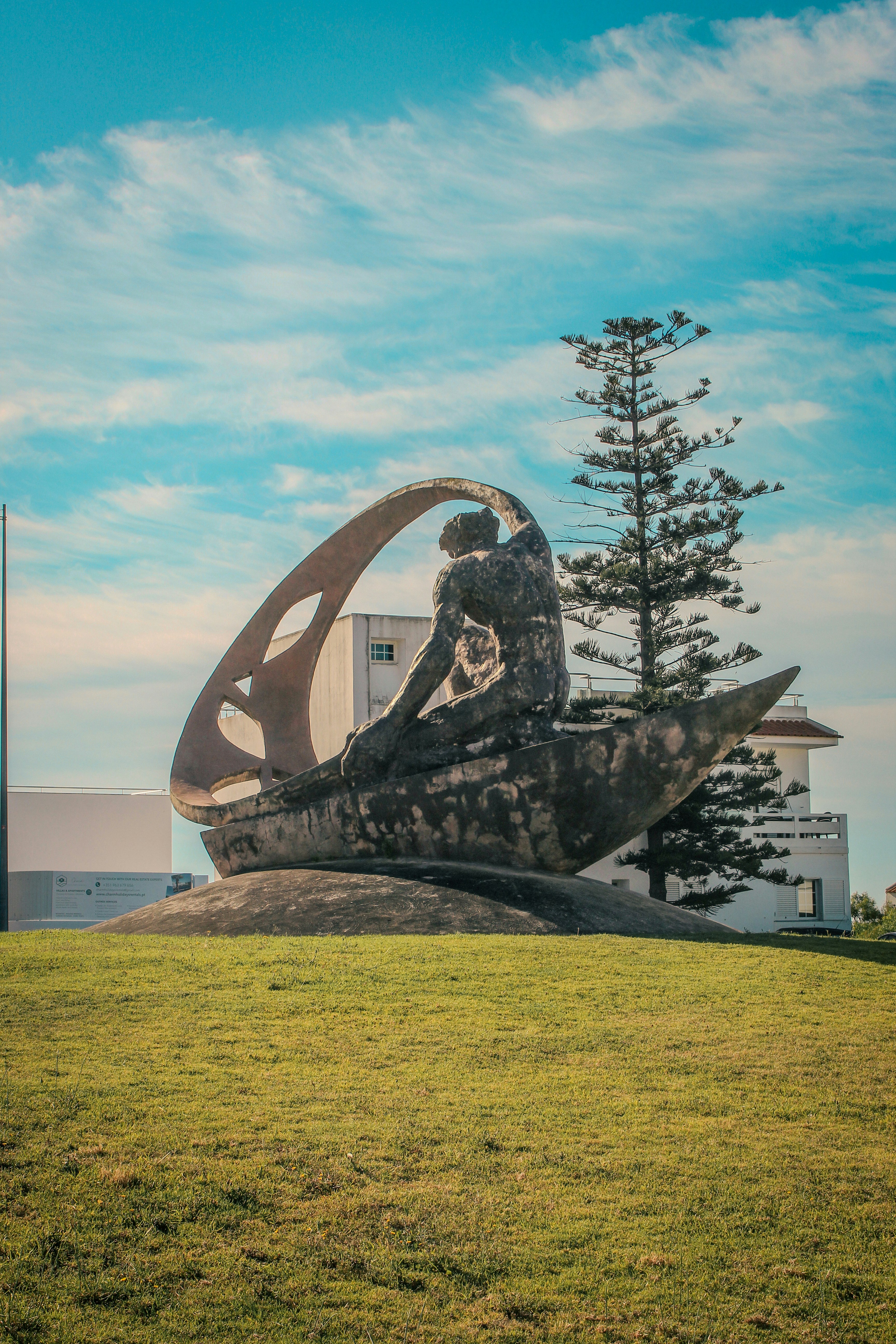 Sail of Time: A Stone Figure Anchored by the Sea-Flat Horizon