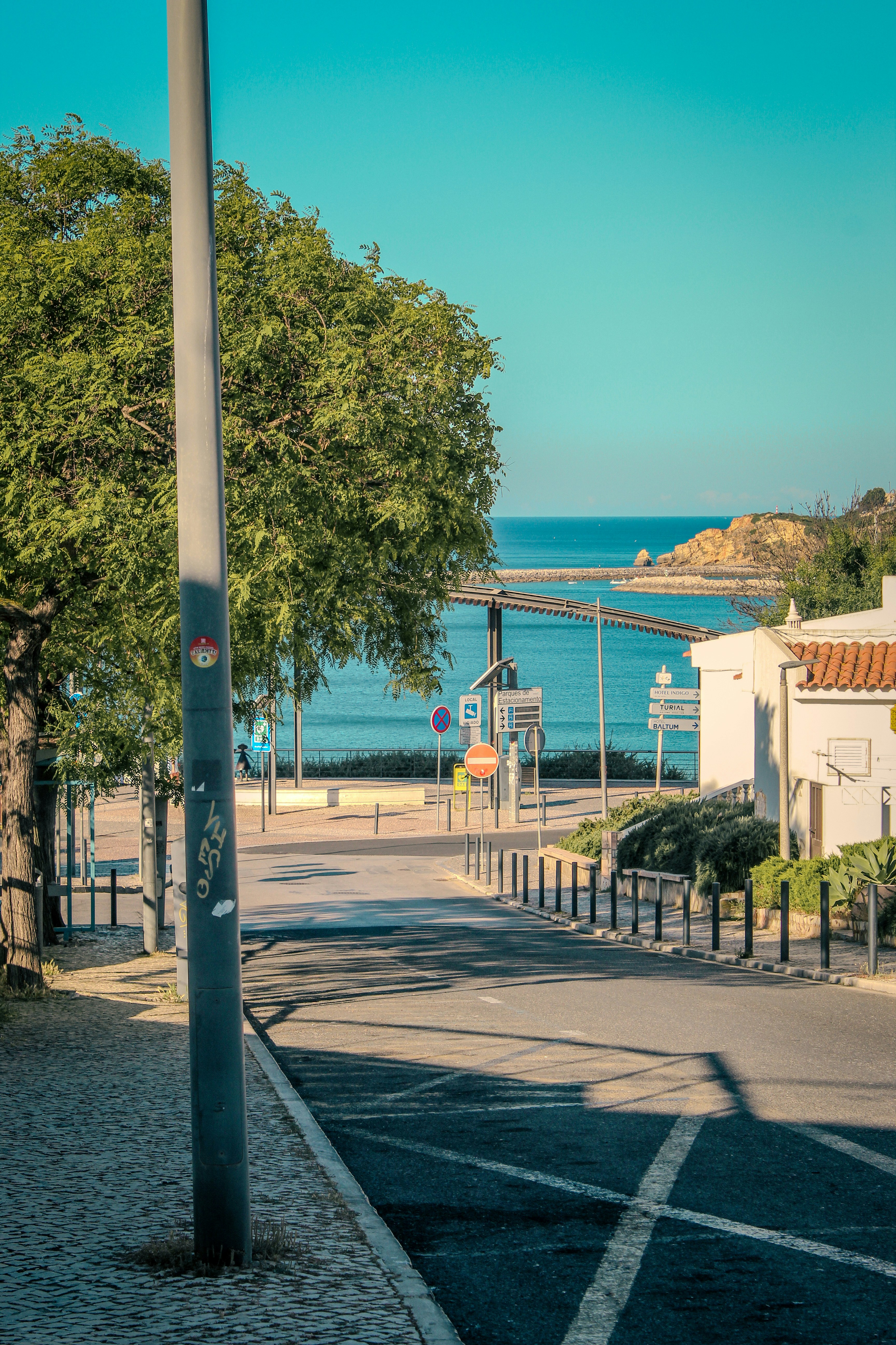 Coastal Street Toward the Sea: A Quiet Path Under a Blue Sky