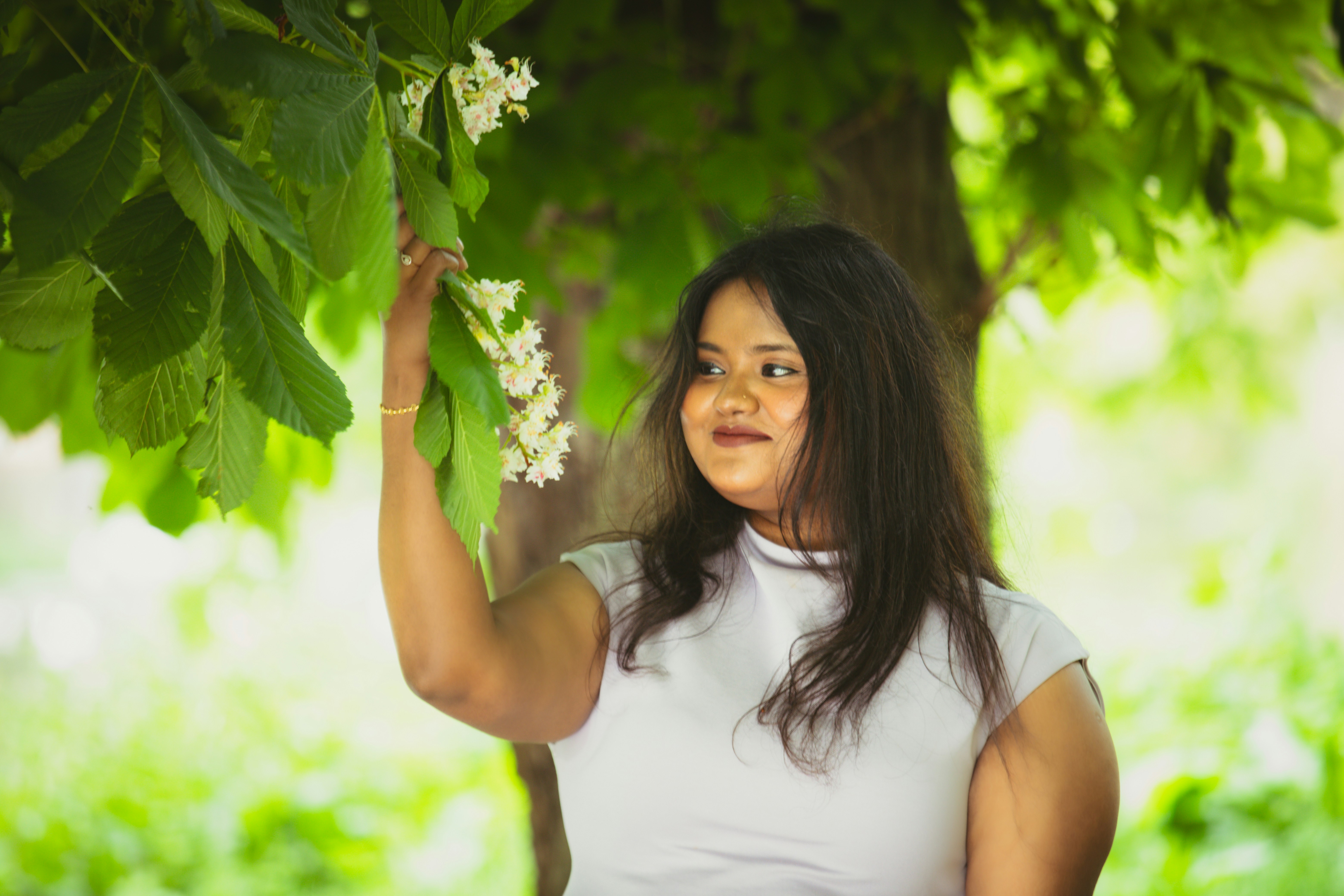 Portrait beneath Blossoming Shade: A Quiet Moment Under the Leaves