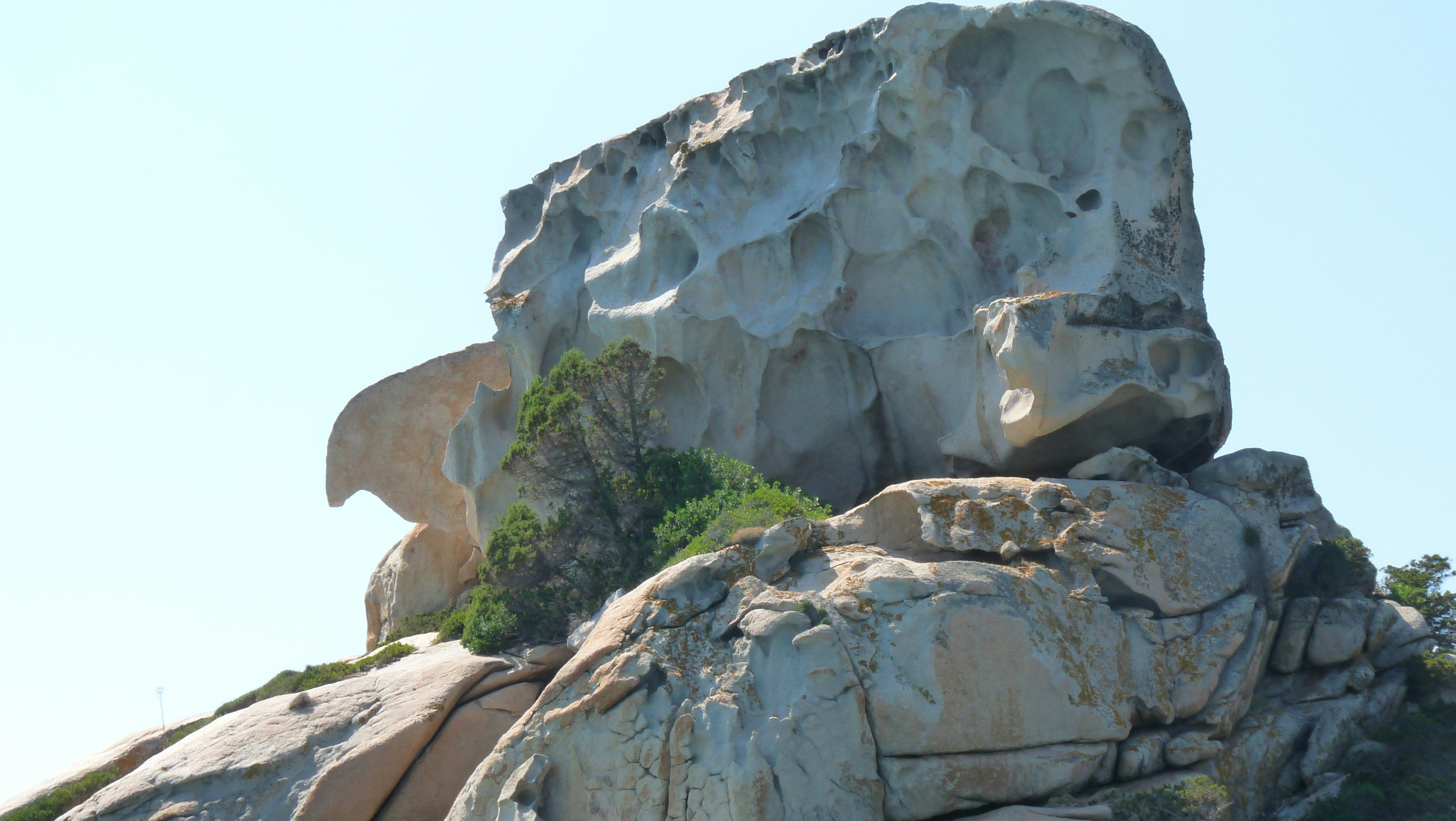 Stone Sentinel: A Weathered Monolith Rising Over Granite Slopes