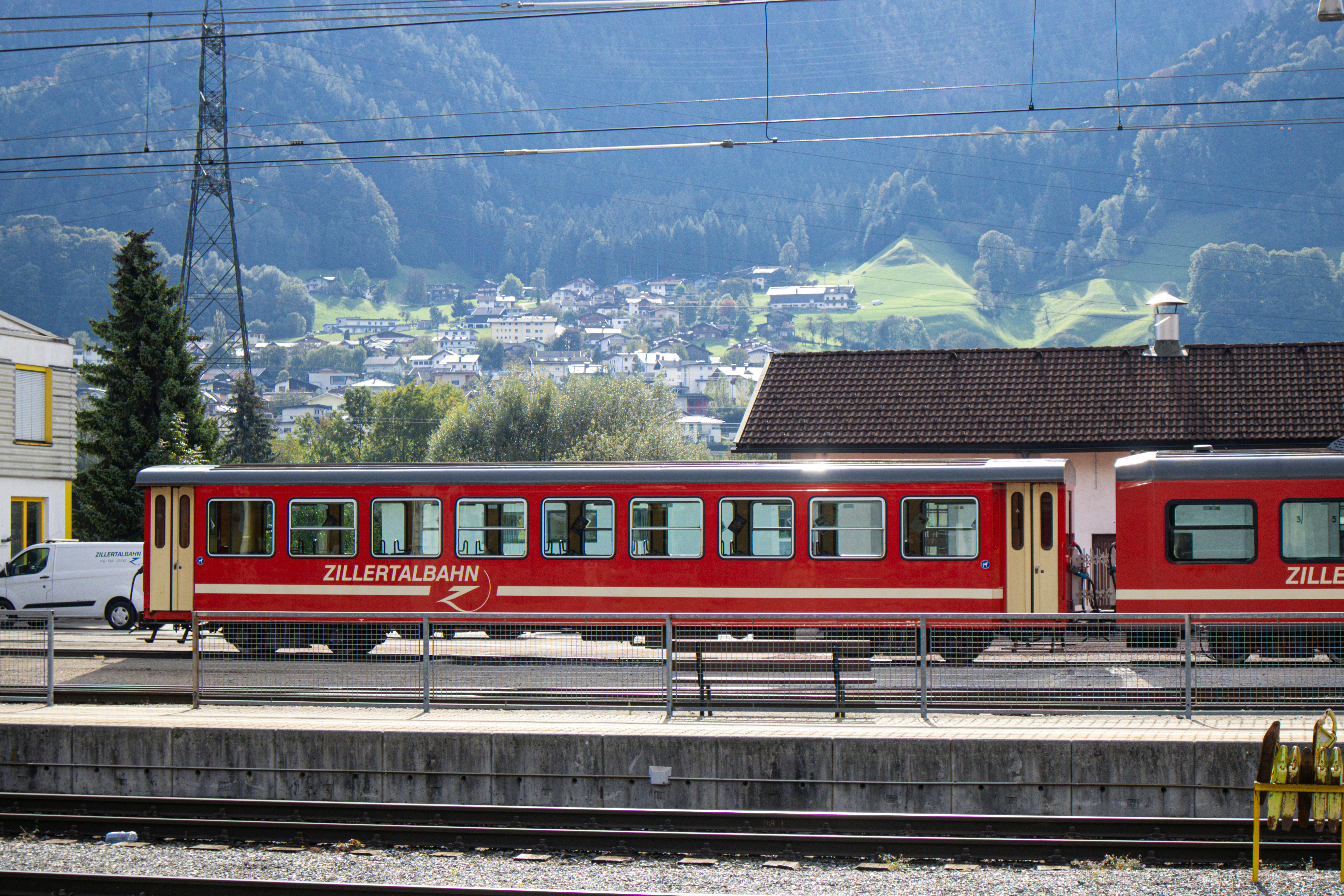 Red Railcar at a Swiss Station: Quiet Transit Against Alpine Backdrop
