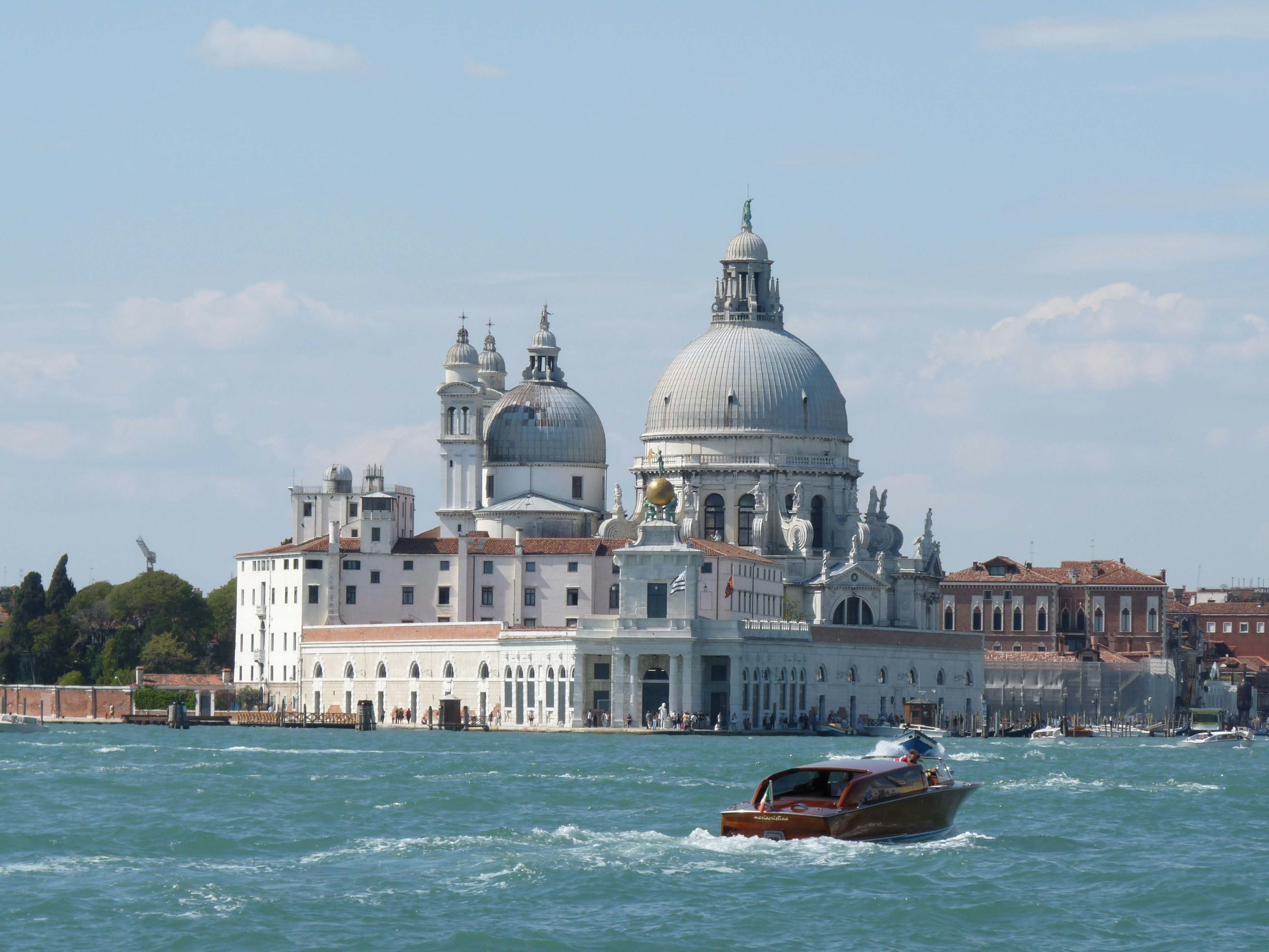 Venetian Dome by the Waterfront: A Boat Cut Across the Lagoon