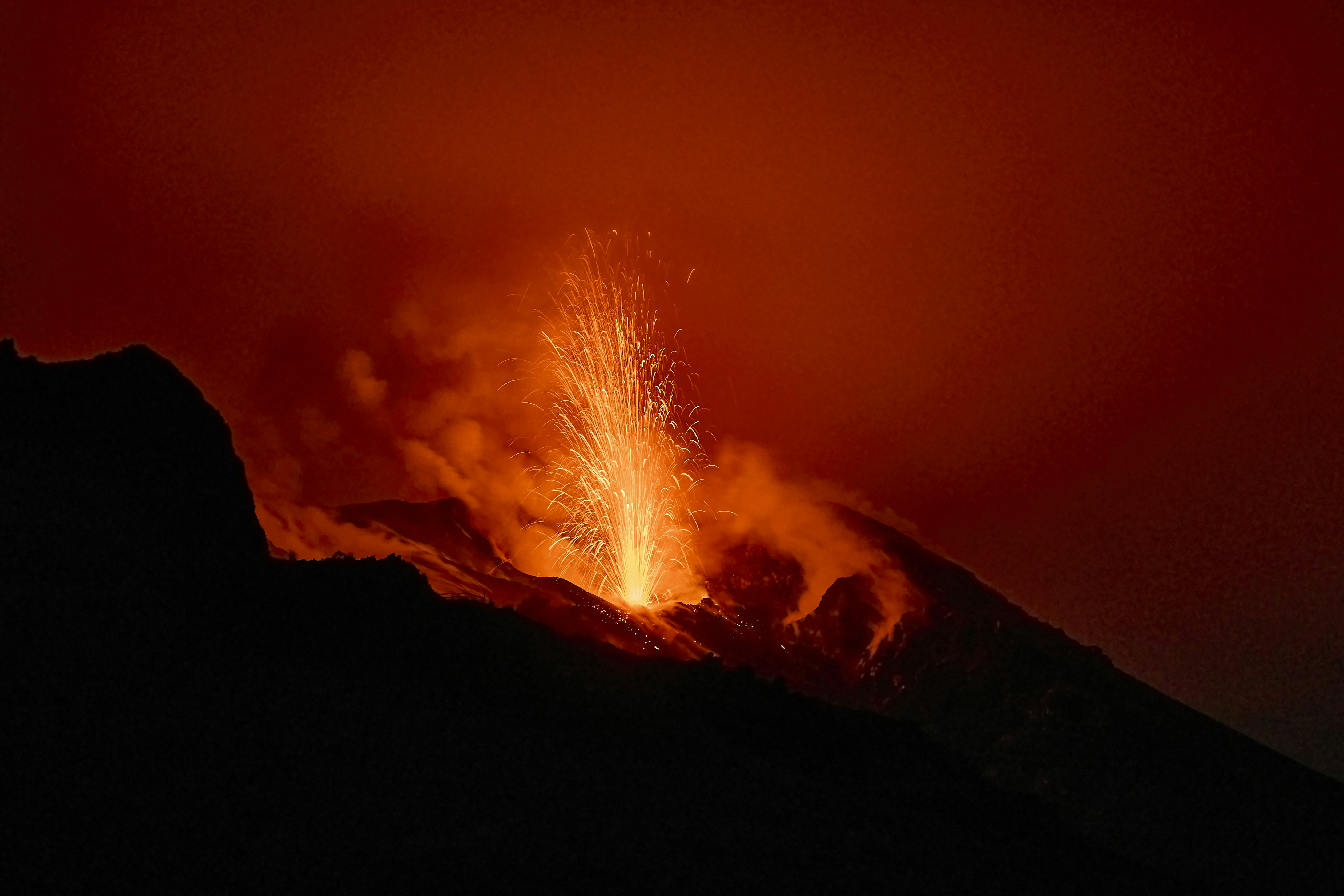 Lava Fountain at Night: A Fiery Plume from a Deserted Volcano