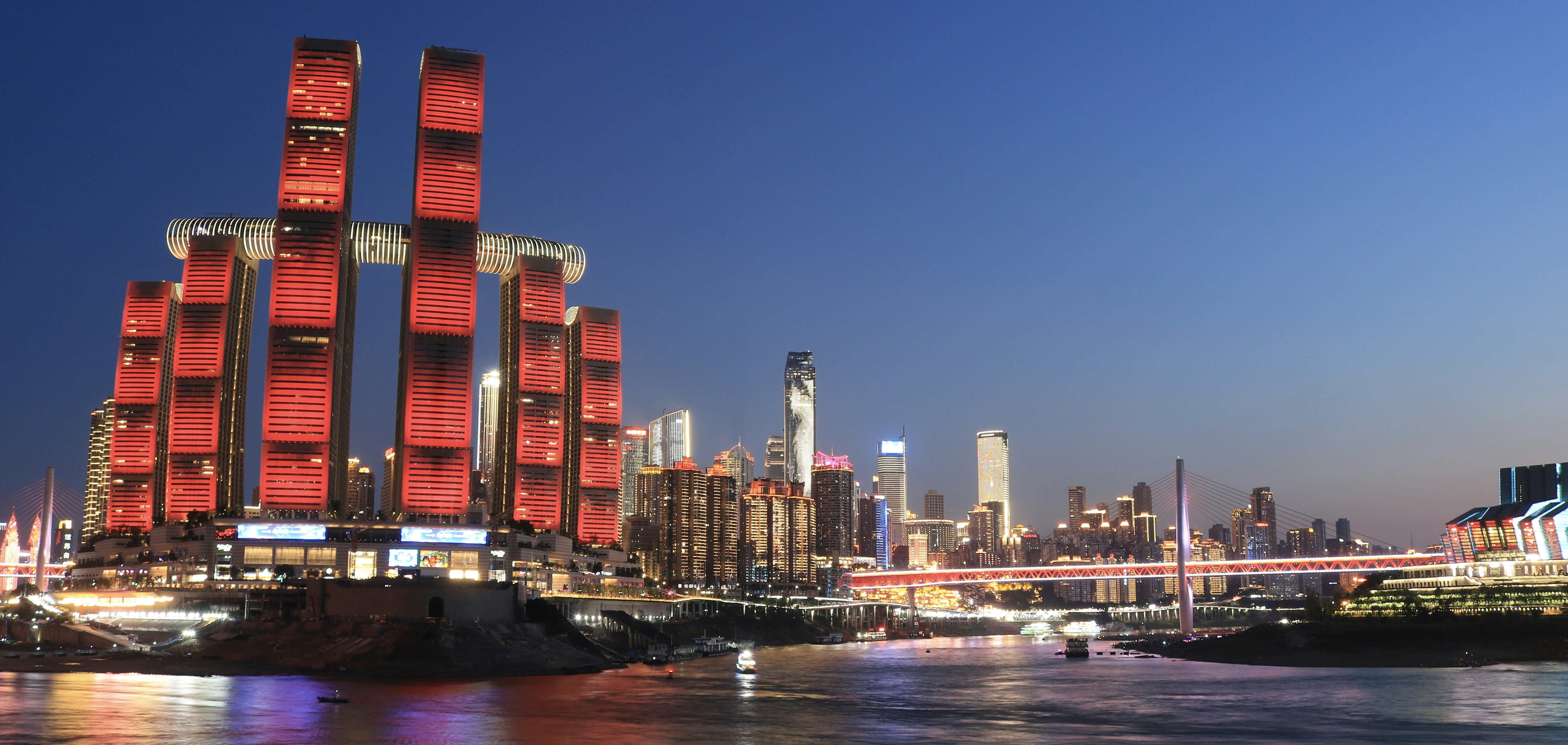 Neon Riverfront Towers: A Glowing Skyline at Dusk