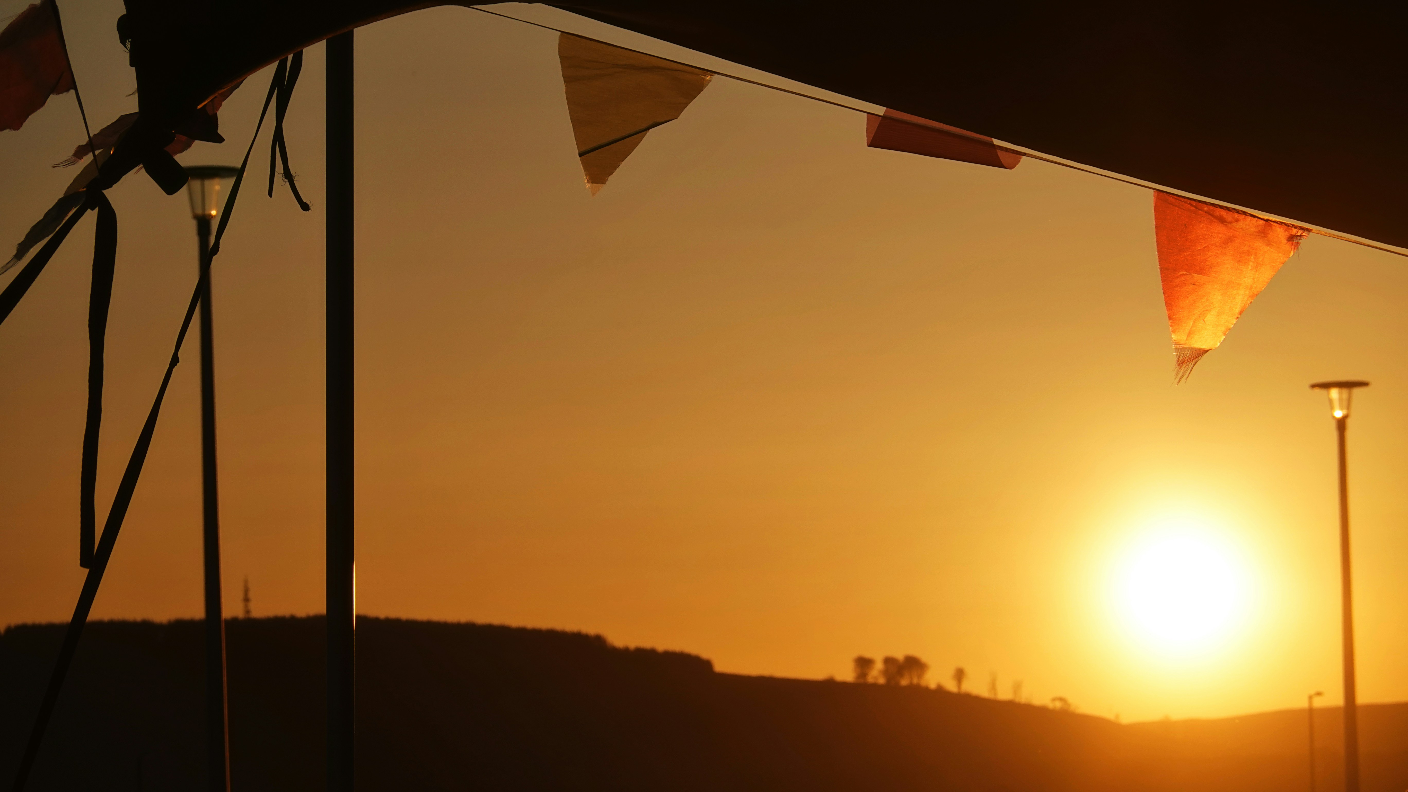 Sunset Flags and Silhouettes over a Quiet Horizon