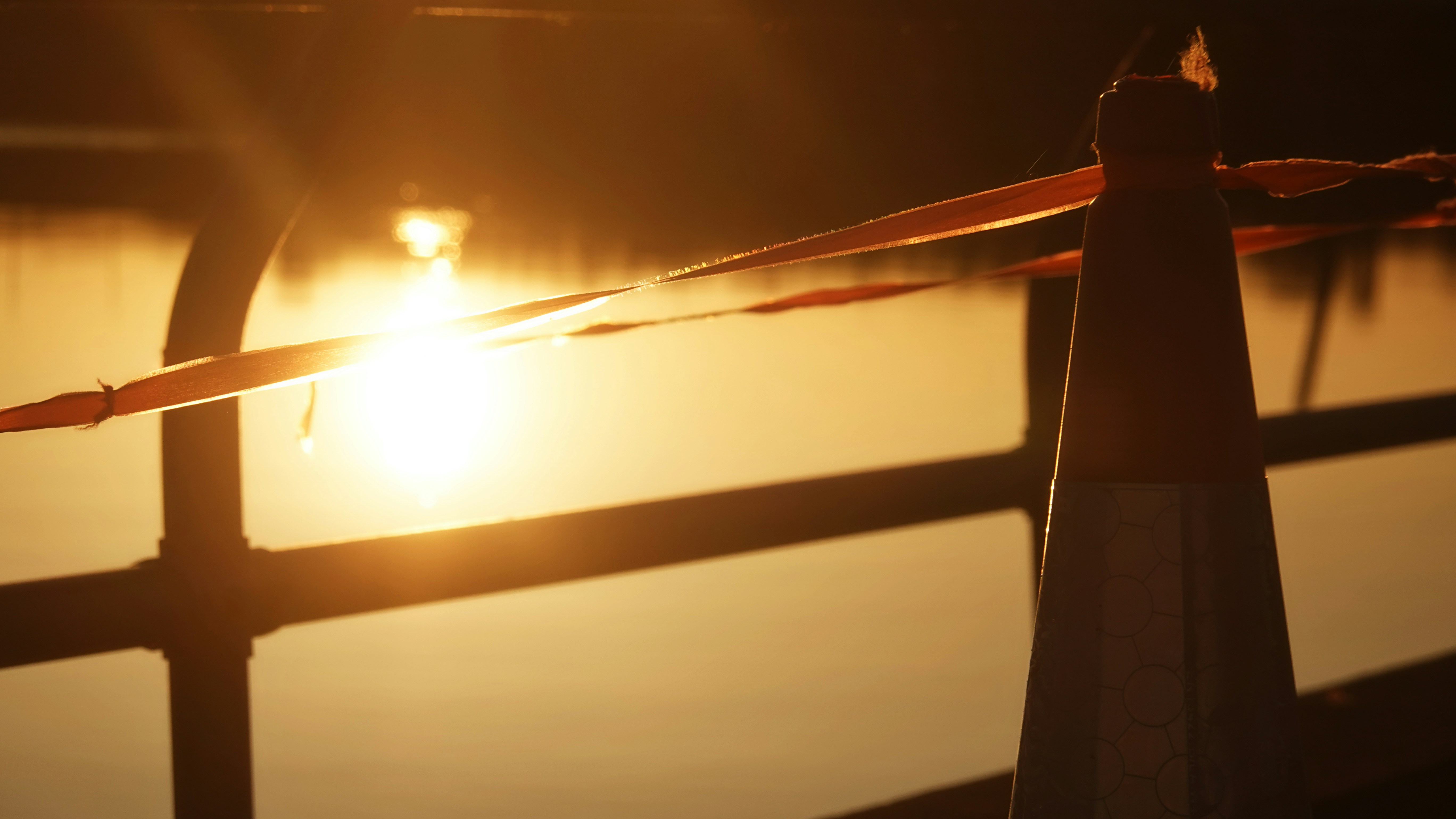 Sunset Ripple: A Rope Barrier and Framing Sun