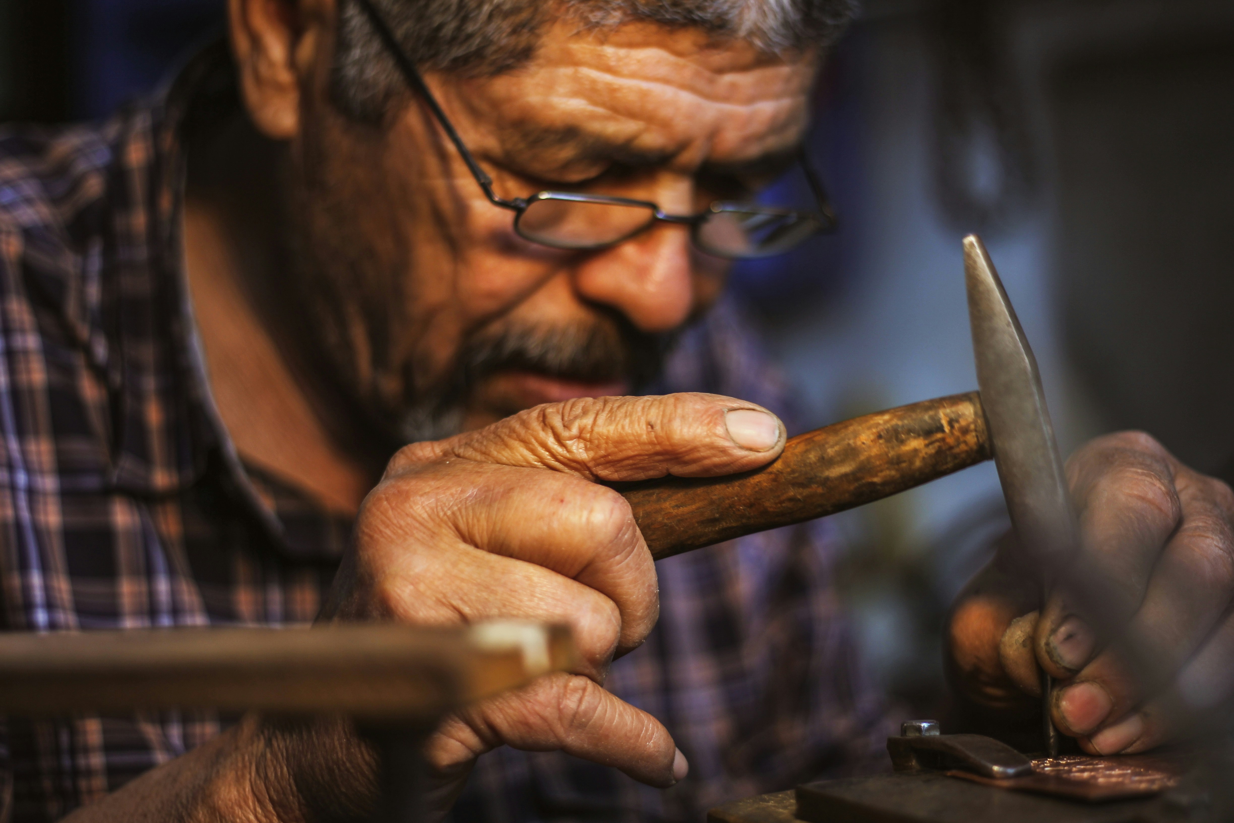 A man crafts souvenirs in Djerbahood, located in Djerba, Tunisia, which carries deep traces of history with its narrow streets, traditional architecture, and historic buildings, captivating its visitors on May 02, 2026.