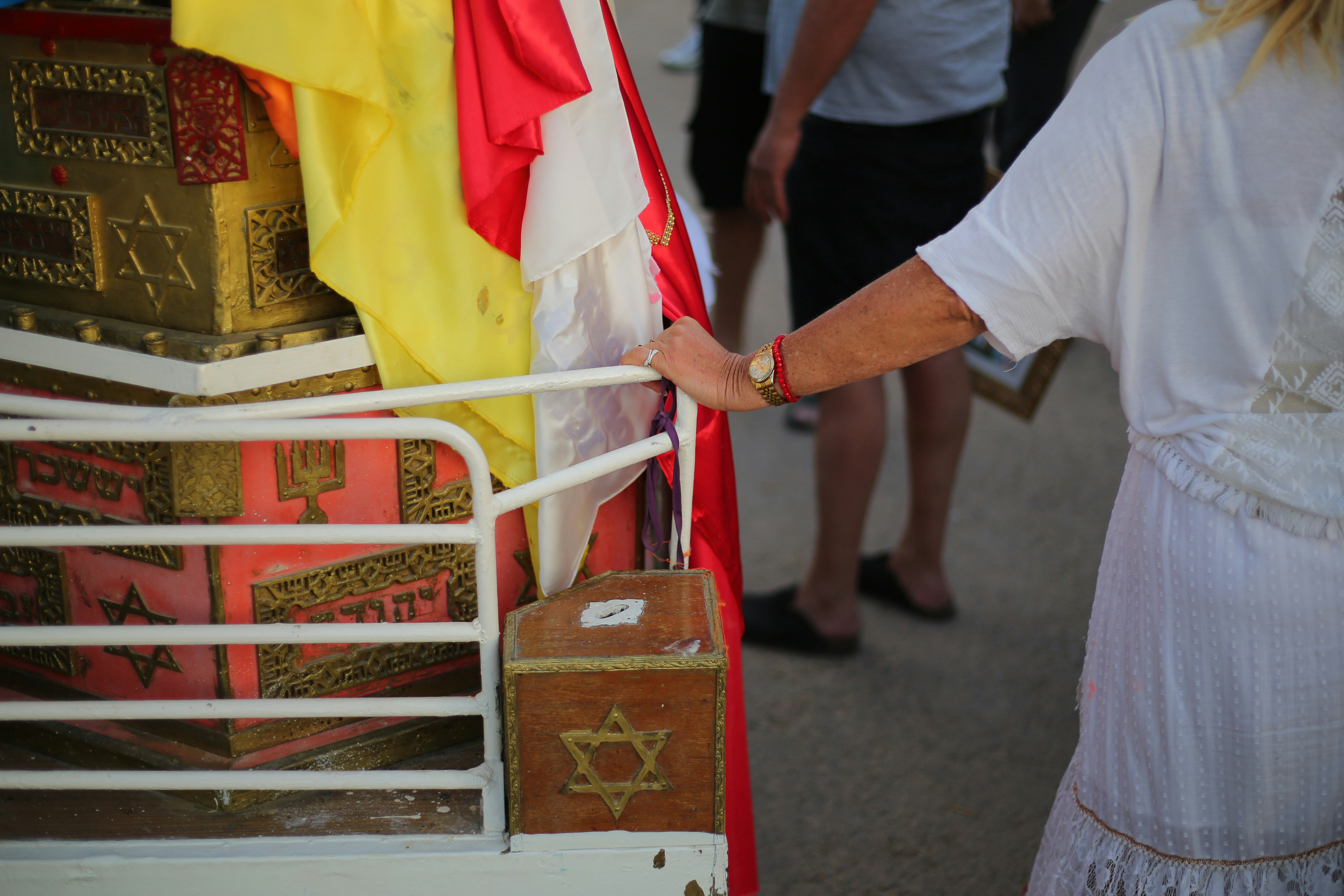 Hands on the Cart: A Quiet Moment with Sacred Containers